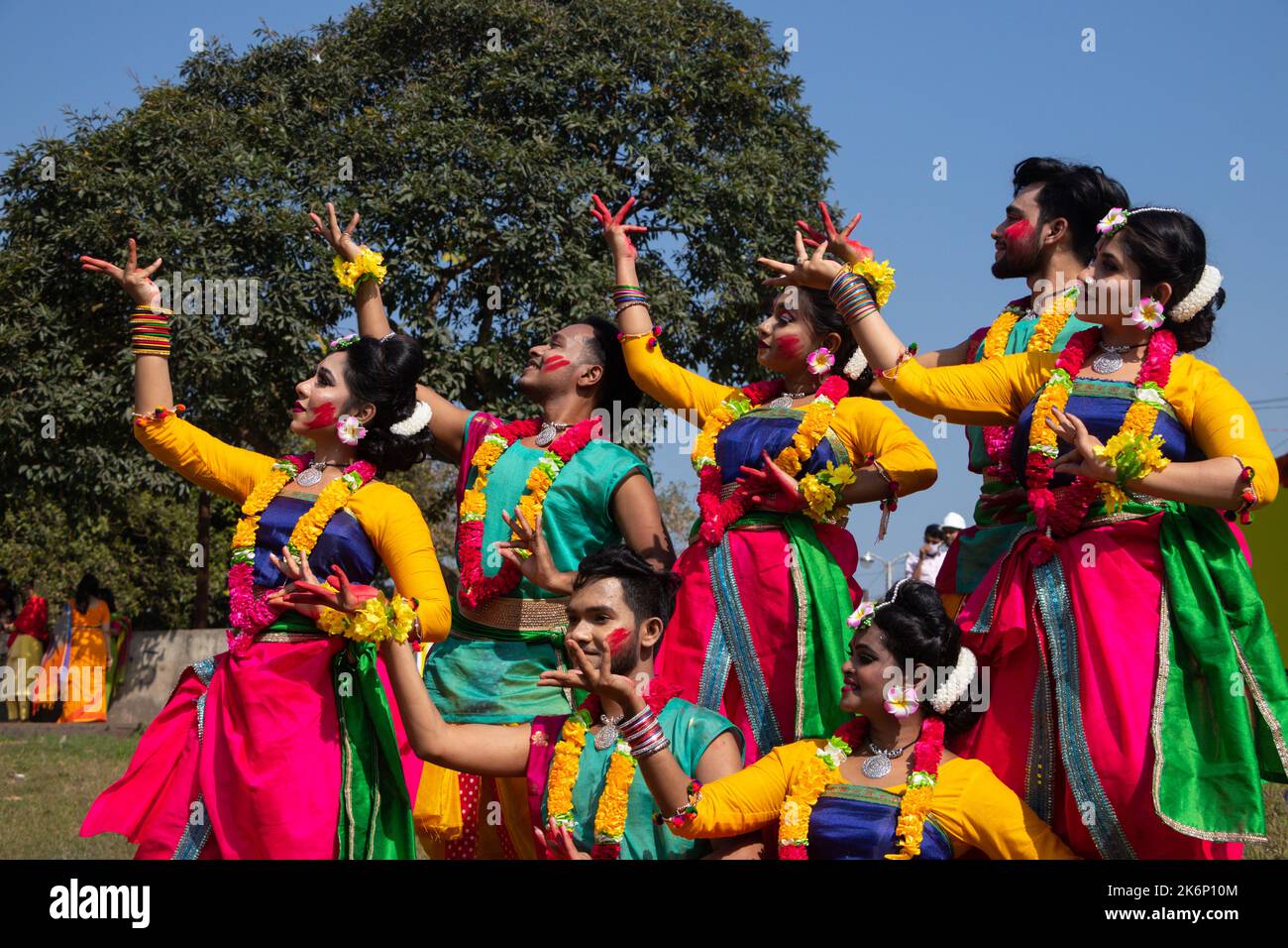 Women wear traditional dresses with floral ornaments and perform during ...