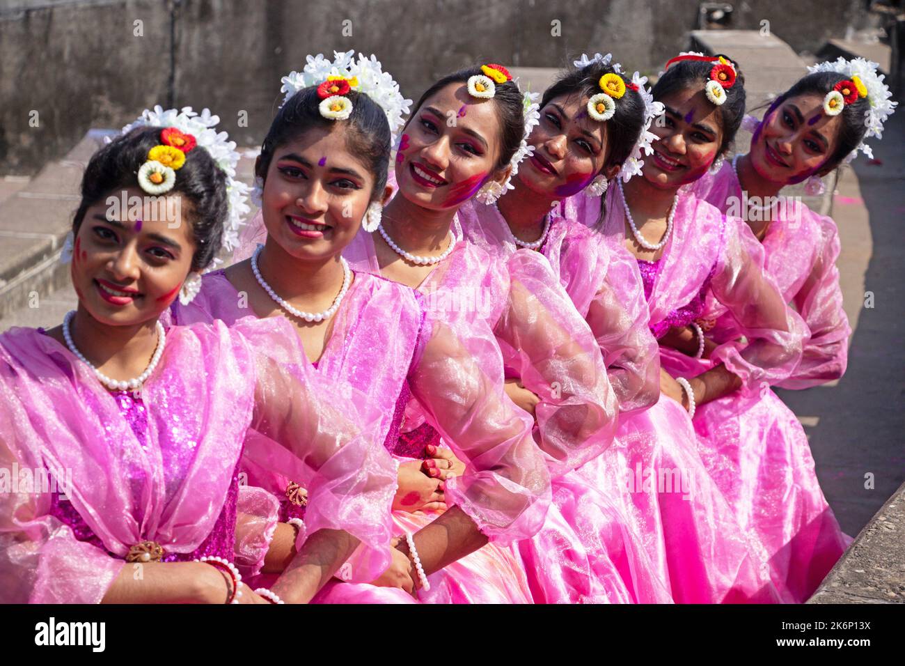 Women wear traditional dresses with floral ornaments and perform during ...