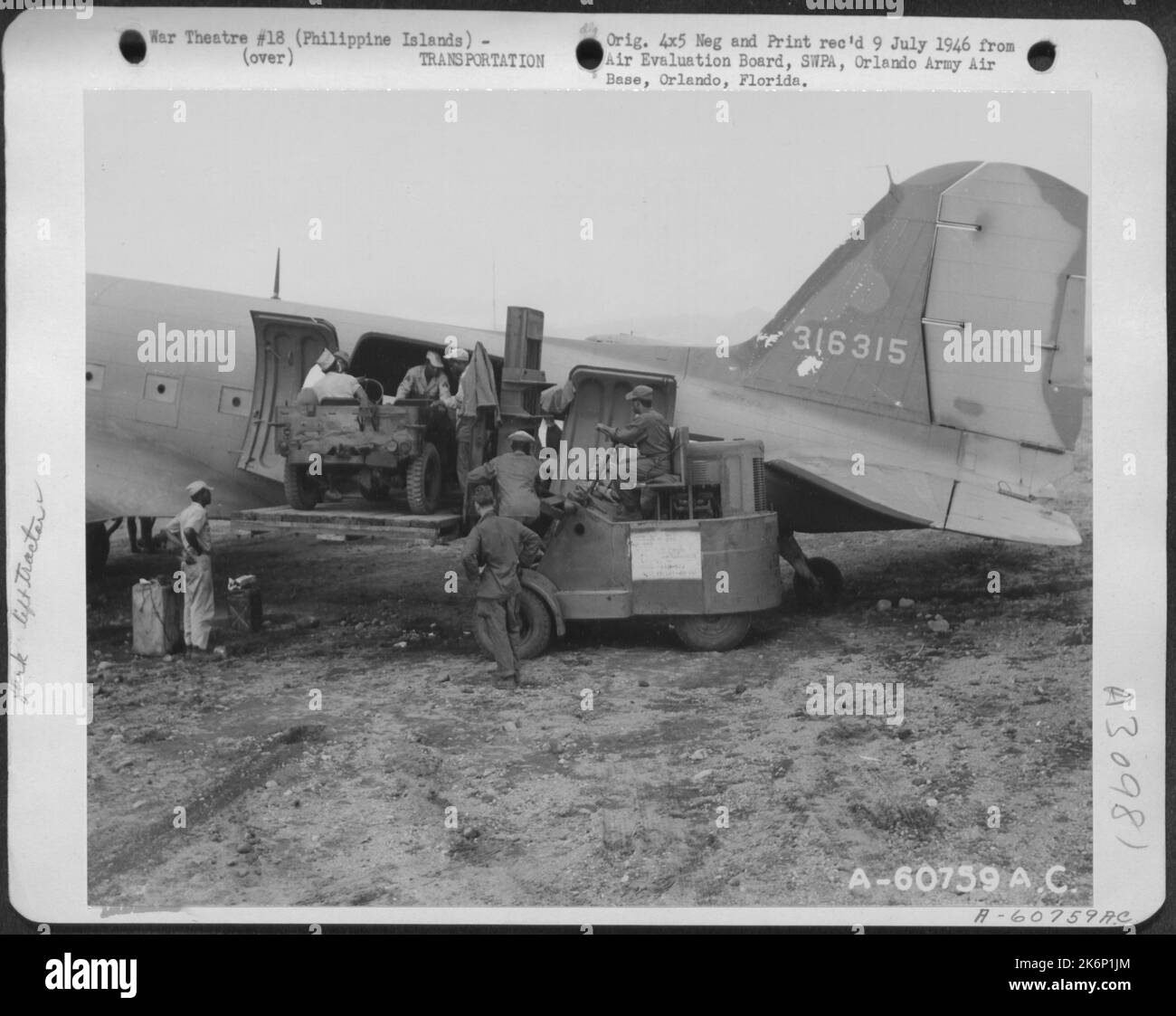 A fork lift truck and pallet used for loading jeep into a C-47 ...