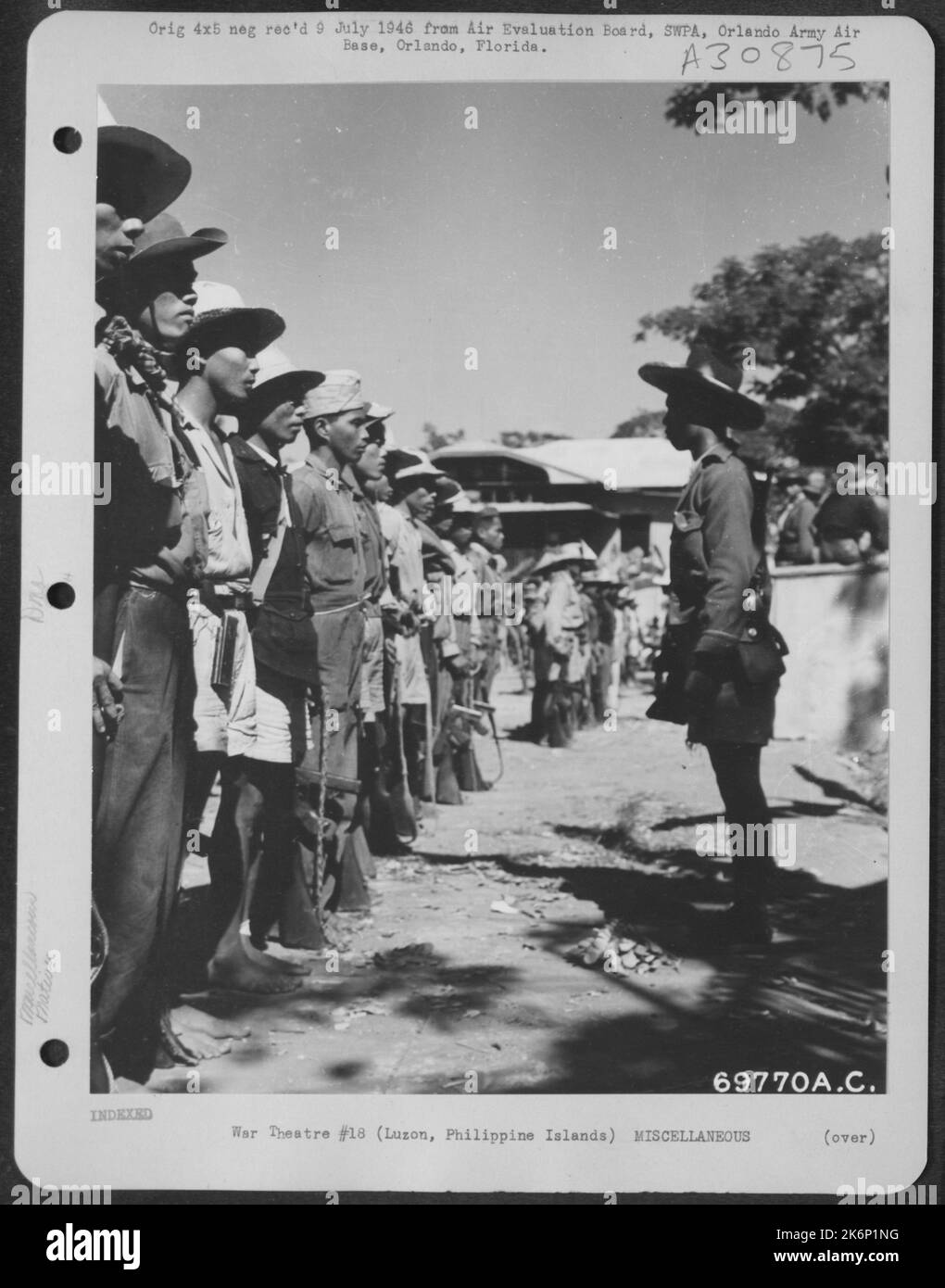 A guerrilla unit at Manaoag, Luzon, Philippine Islands, is inspected by ...