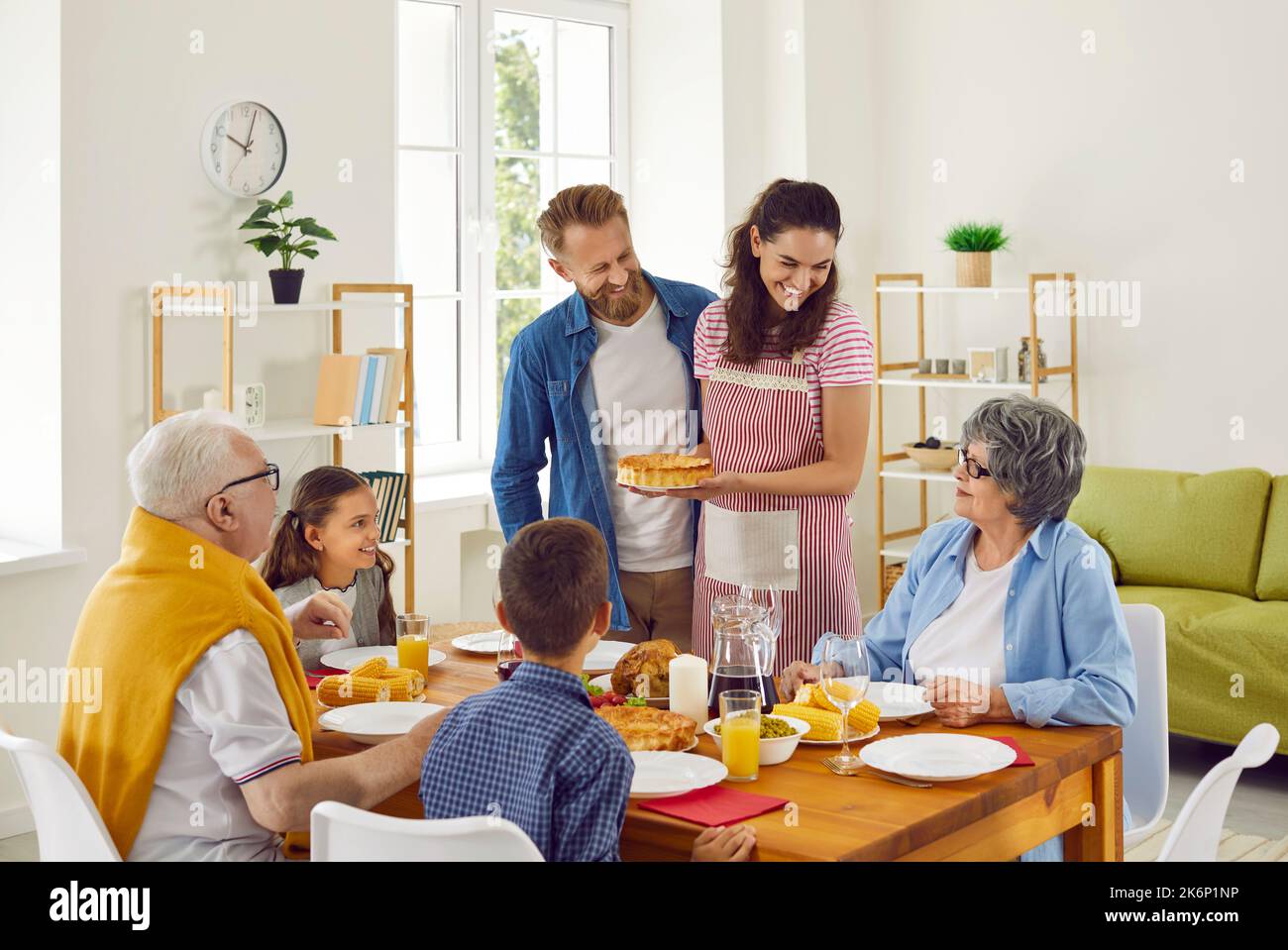 Married couple is serving holiday pie at Thanksgiving celebration with ...