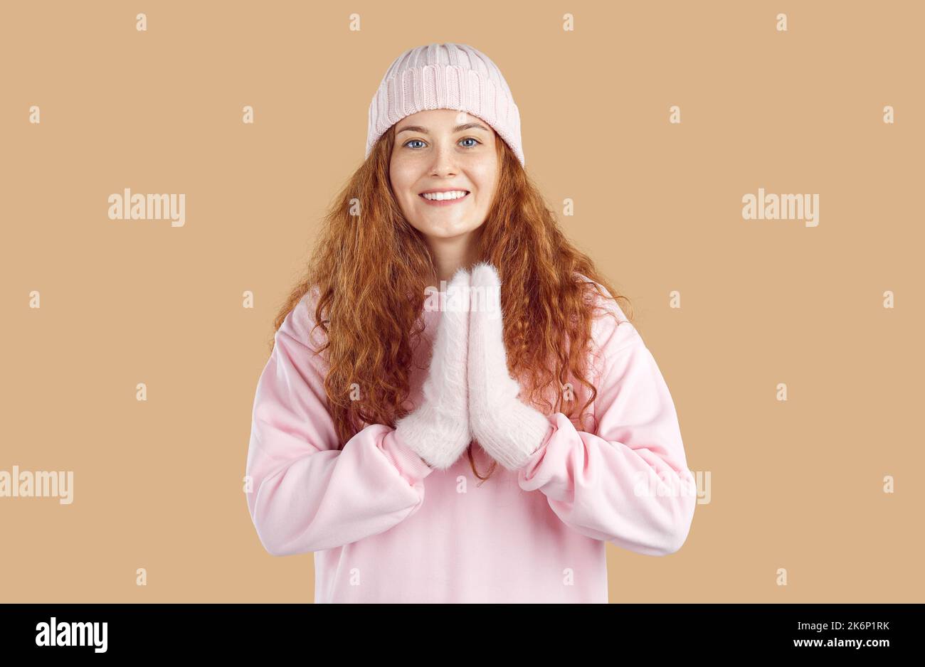 Portrait of joyful woman clapping her hands joyfully in winter in ...