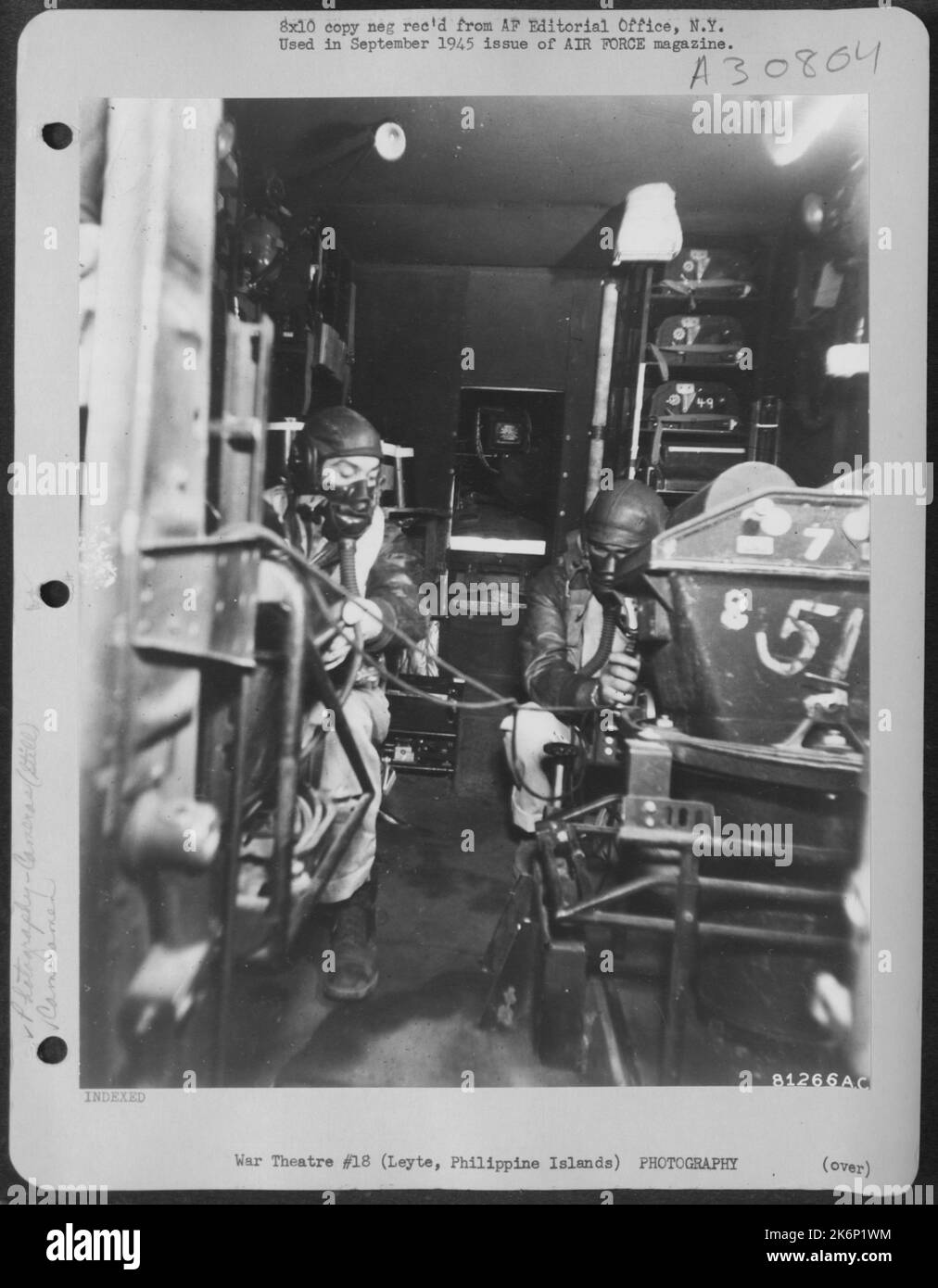 Aerial cameraman in the camera bay of an F-7 photo reconnaissance plane ...