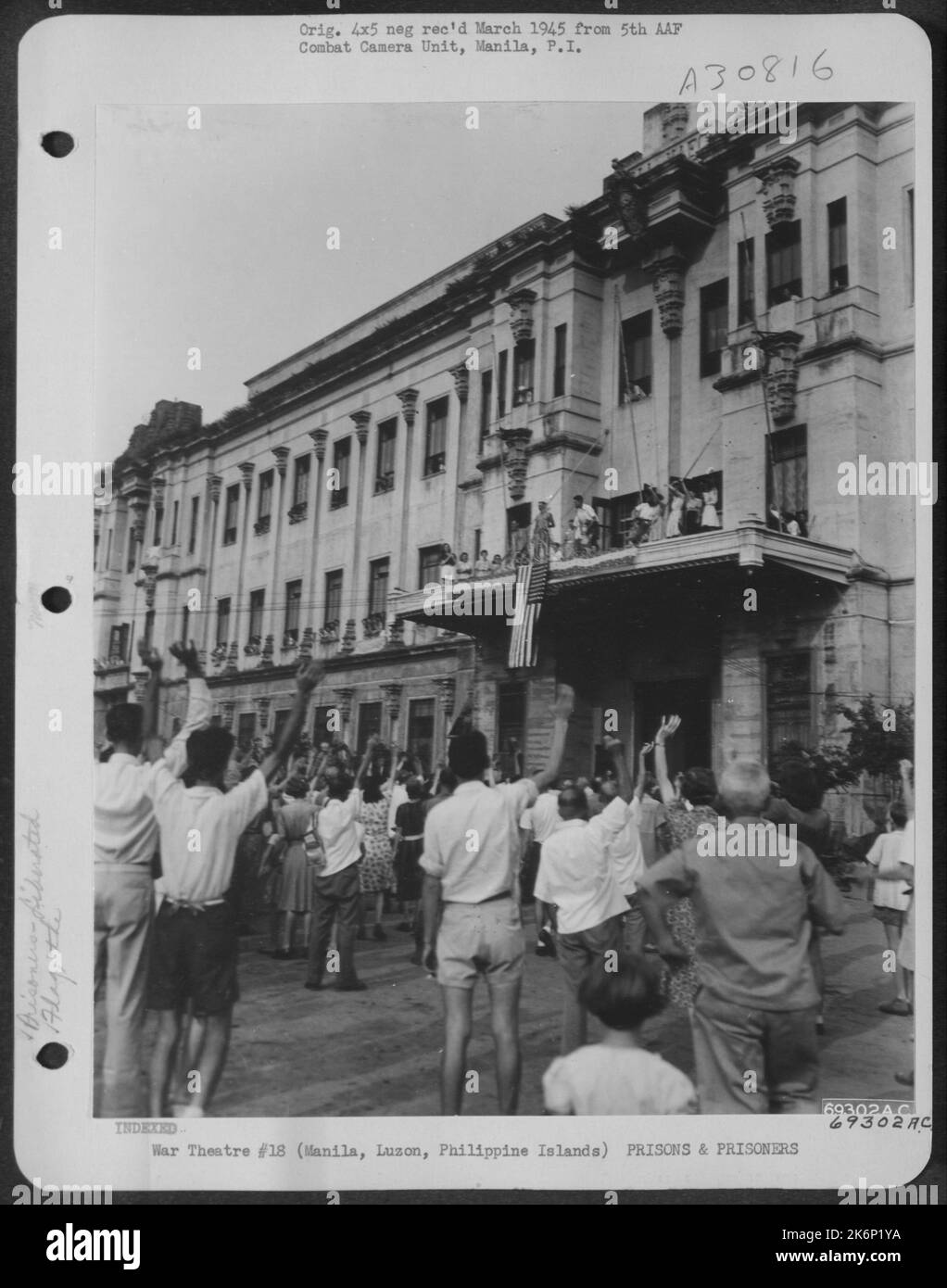 The first American flag to be raised at Santo Tomas Prison in over ...