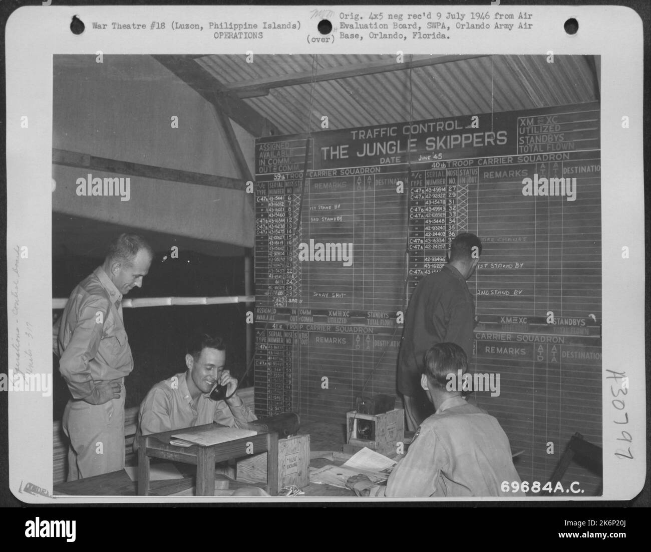 Operations officer of the 317th Troop Carrier Group receives calls for ...