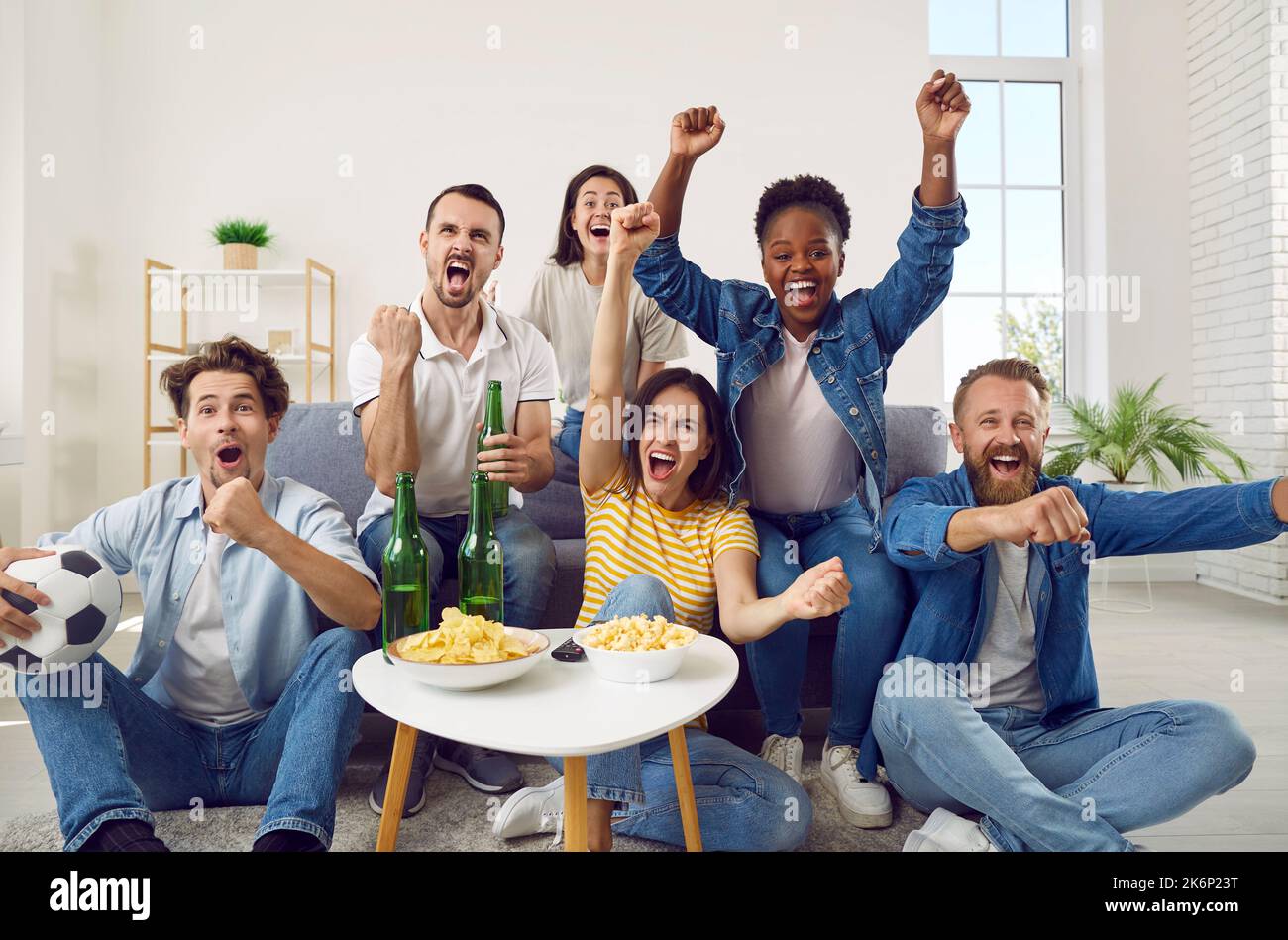 Group of happy diverse friends cheering and screaming while watching ...