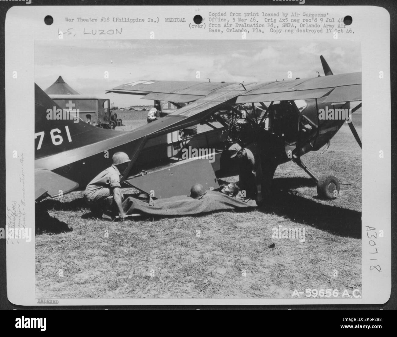Litter Case Being Loaded Into Vultee L 5 At Landing Strip On Luzon Philippine Islands Stock