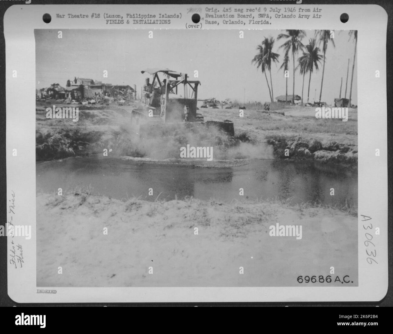 A bulldozer, operated by members of the 836th Engineer Aviation ...