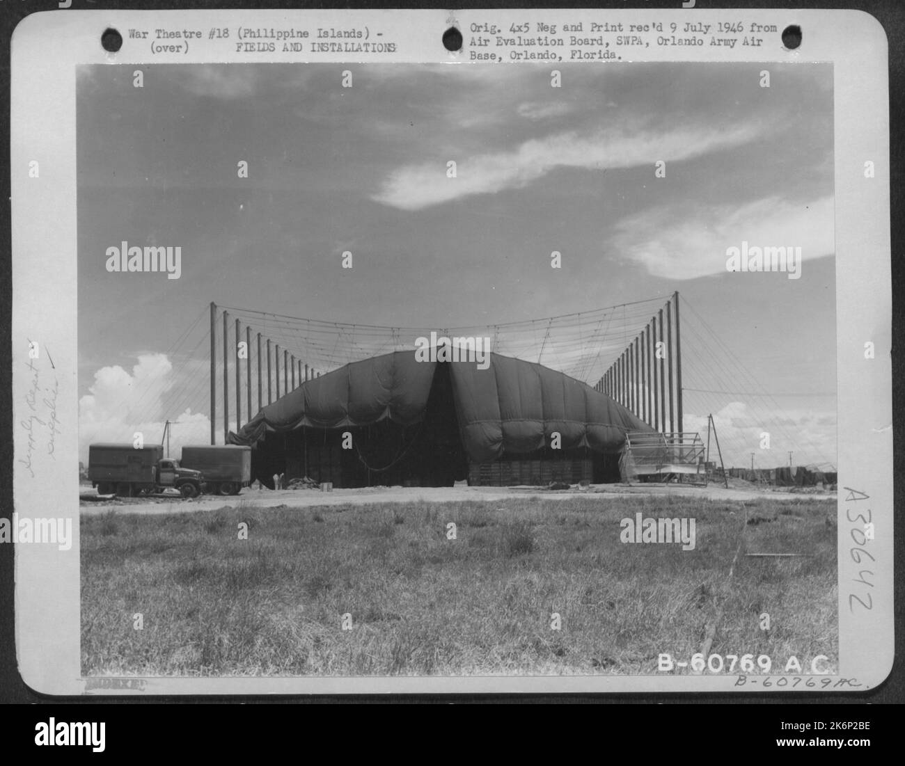 This portable combat canvas-covered hangar is being used as a warehouse ...
