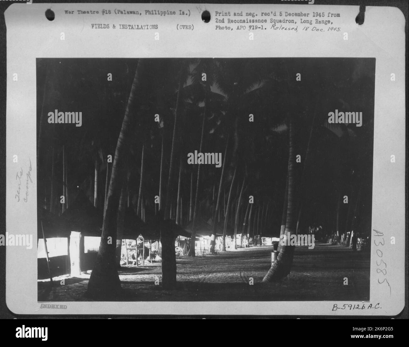 U.S. camp area under palm trees as it looks at night on Palawan ...