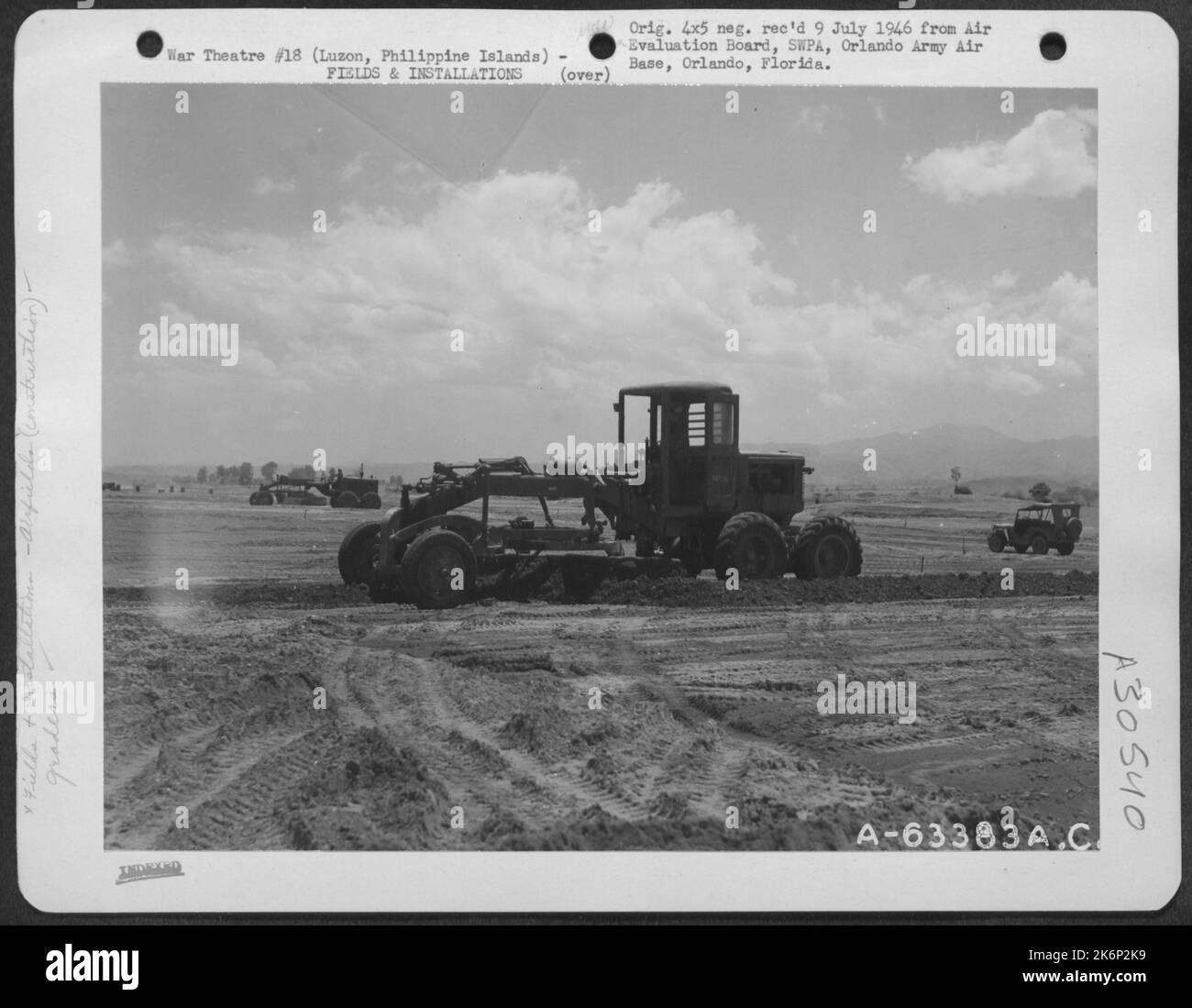 A grader leveling the surface of the strip at Clark Field, 30 April ...