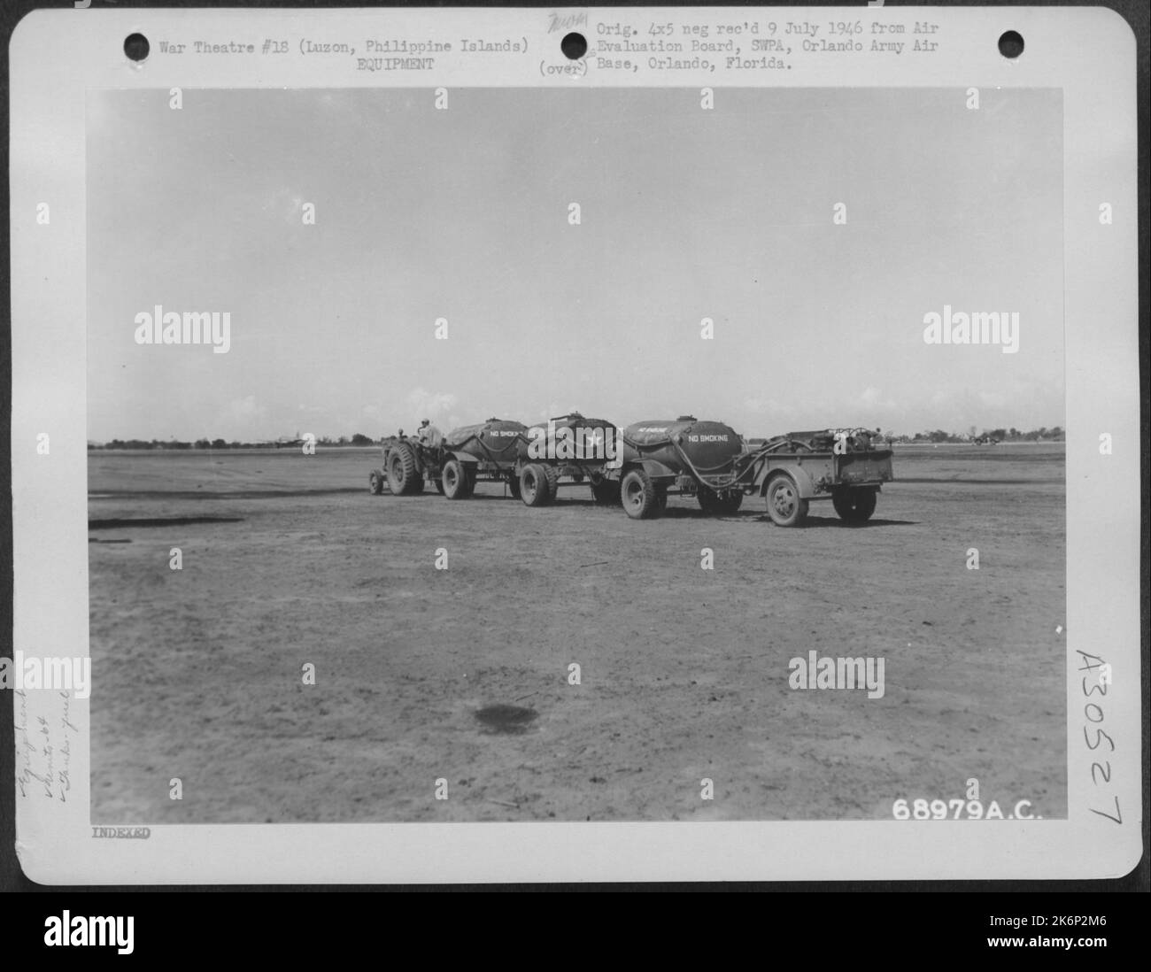 Emergency fuel tanks of the 64th Air Service Group are towed out to the ...