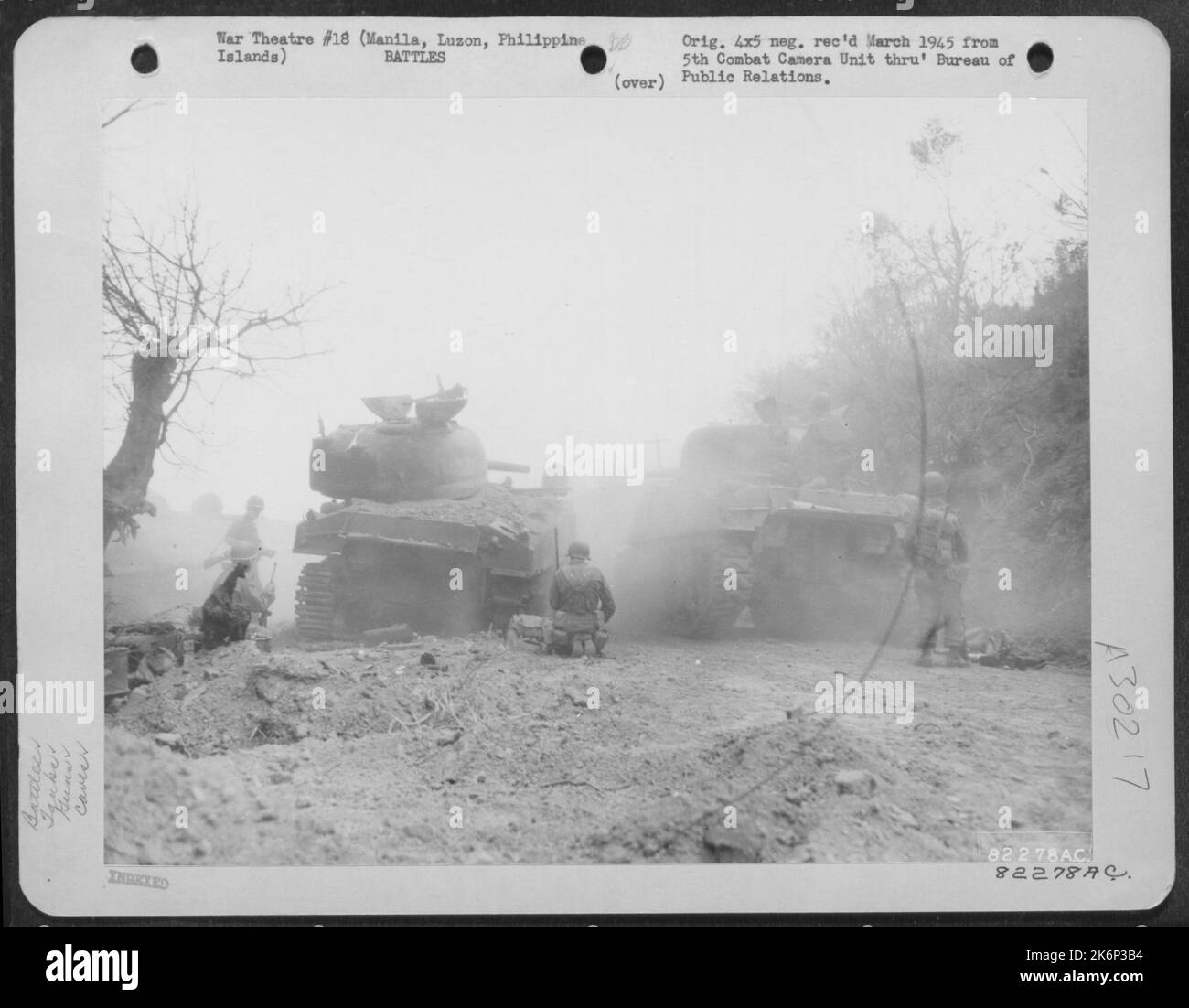 Sherman tanks raise huge clouds of smoke and dust as their 75 mm piece ...