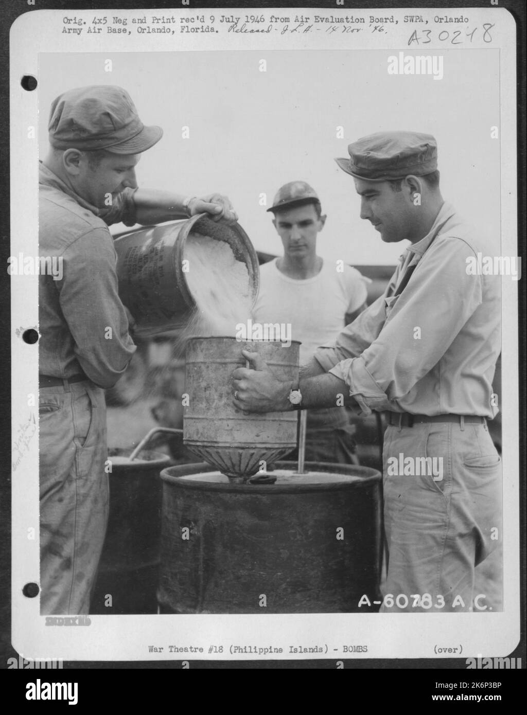 Personnel of the 892nd Chemical Company pouring Napalm into a drum of ...