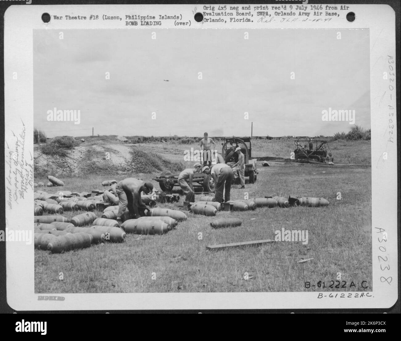 Armament men fitting fins on 250 pound and demolition bombs just before ...