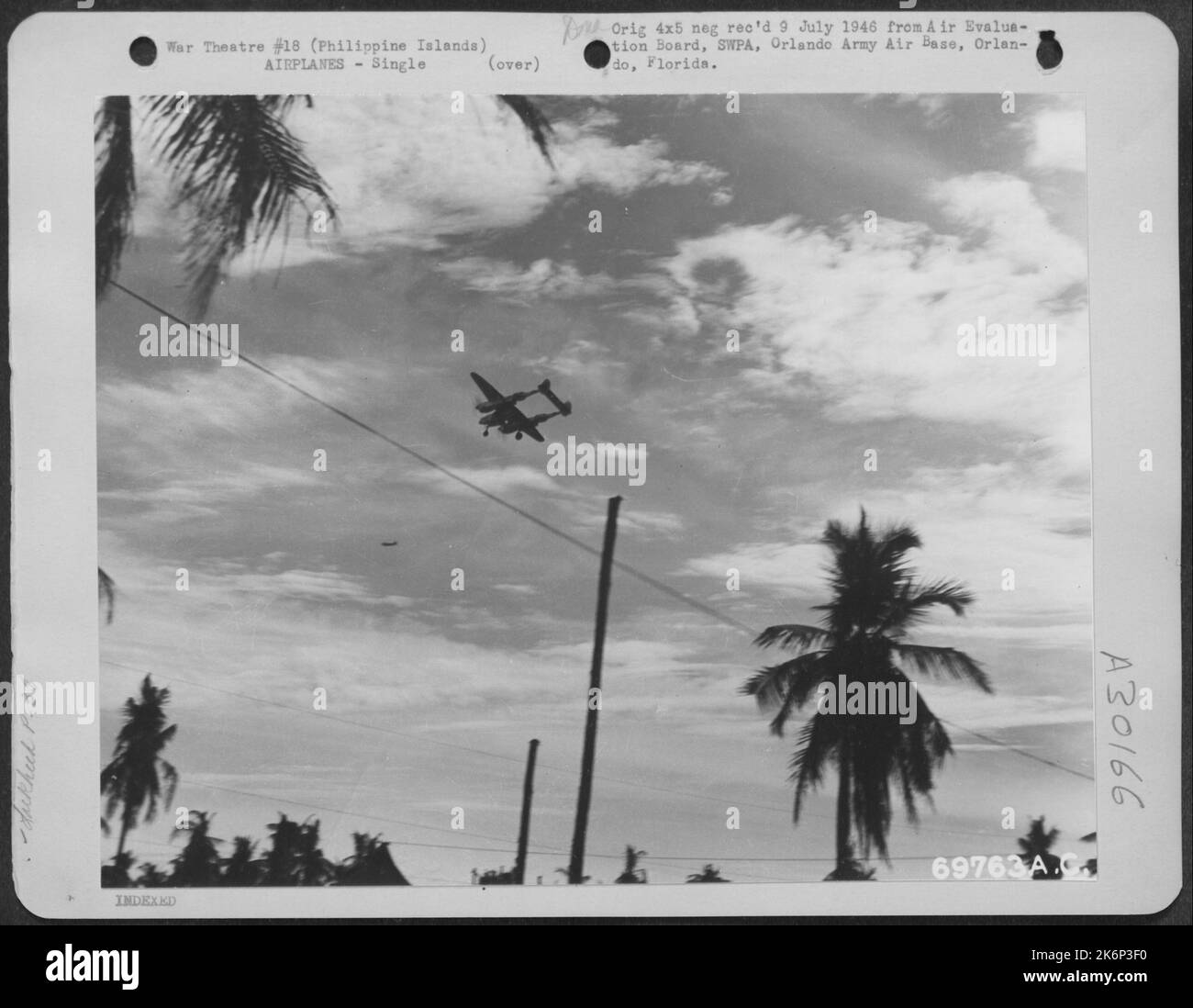 A Lockheed P-38 "Lightning" buzzing a base somewhere in the Philippines ...