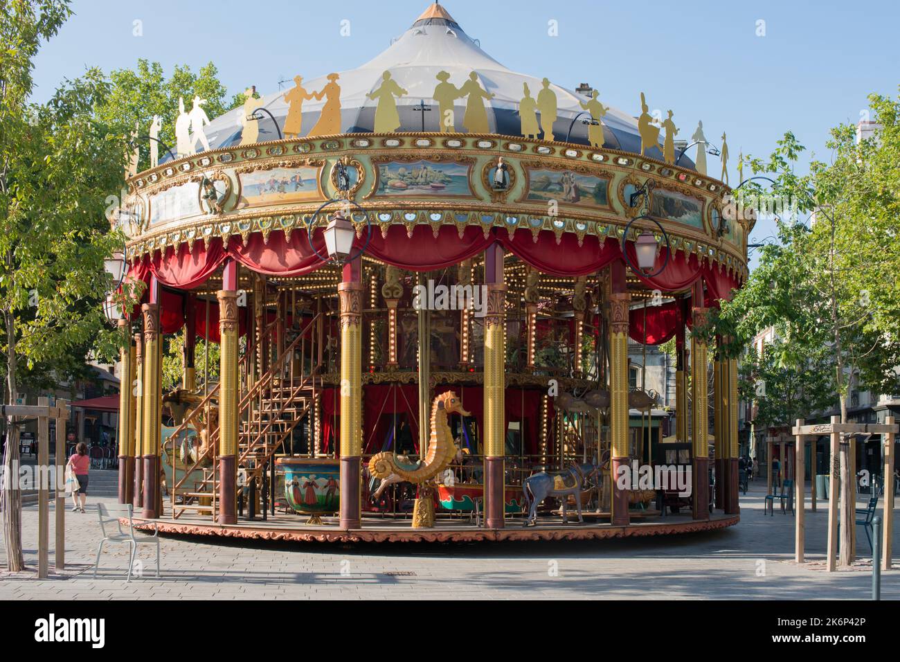 Traditional merry-go-round. Seats in form of rows of wooden animals ...