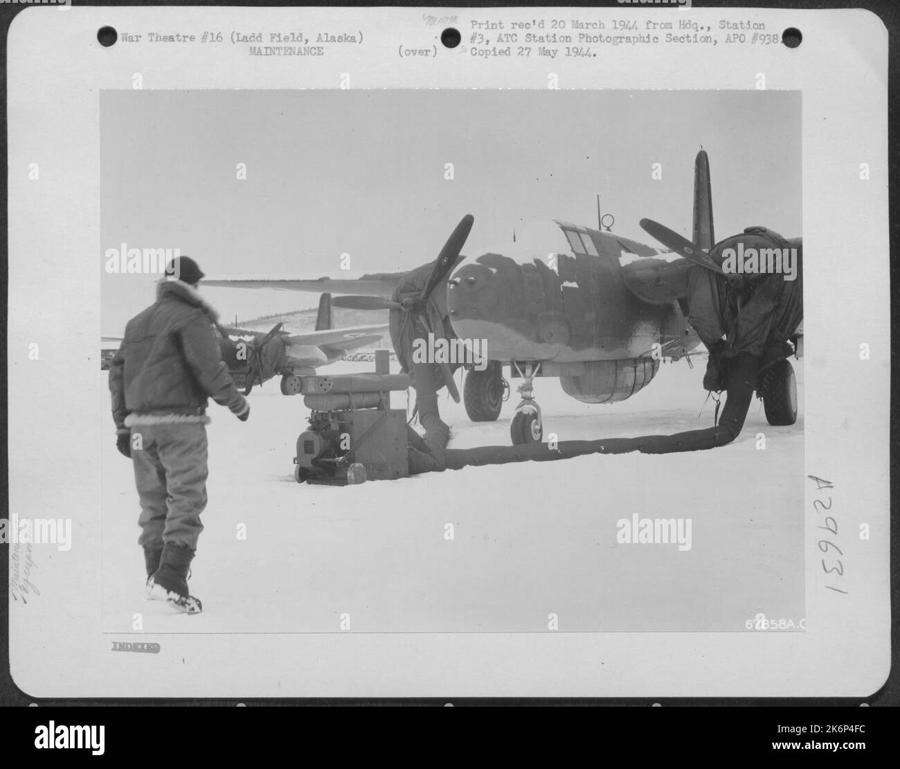 An engine heater is used on this Douglas A-20 during sub-zero weather ...