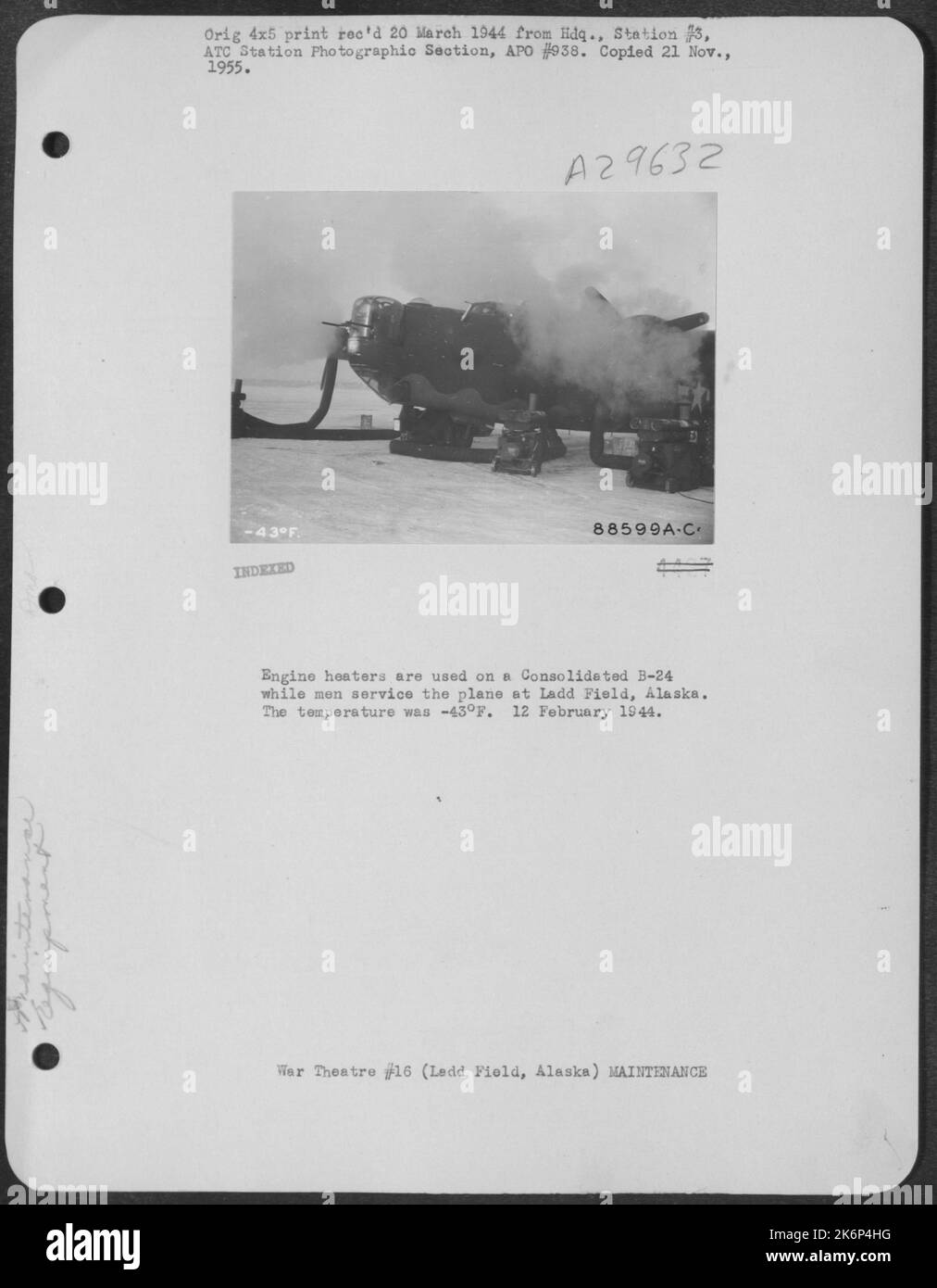 Engine heaters are used on a Consolidated B-24 while men service the ...