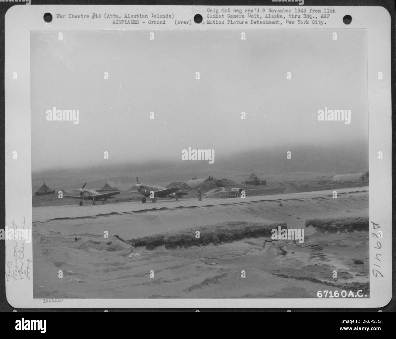 Curtiss P-40's are parked on a Marston mat strip at Alexai Point ...