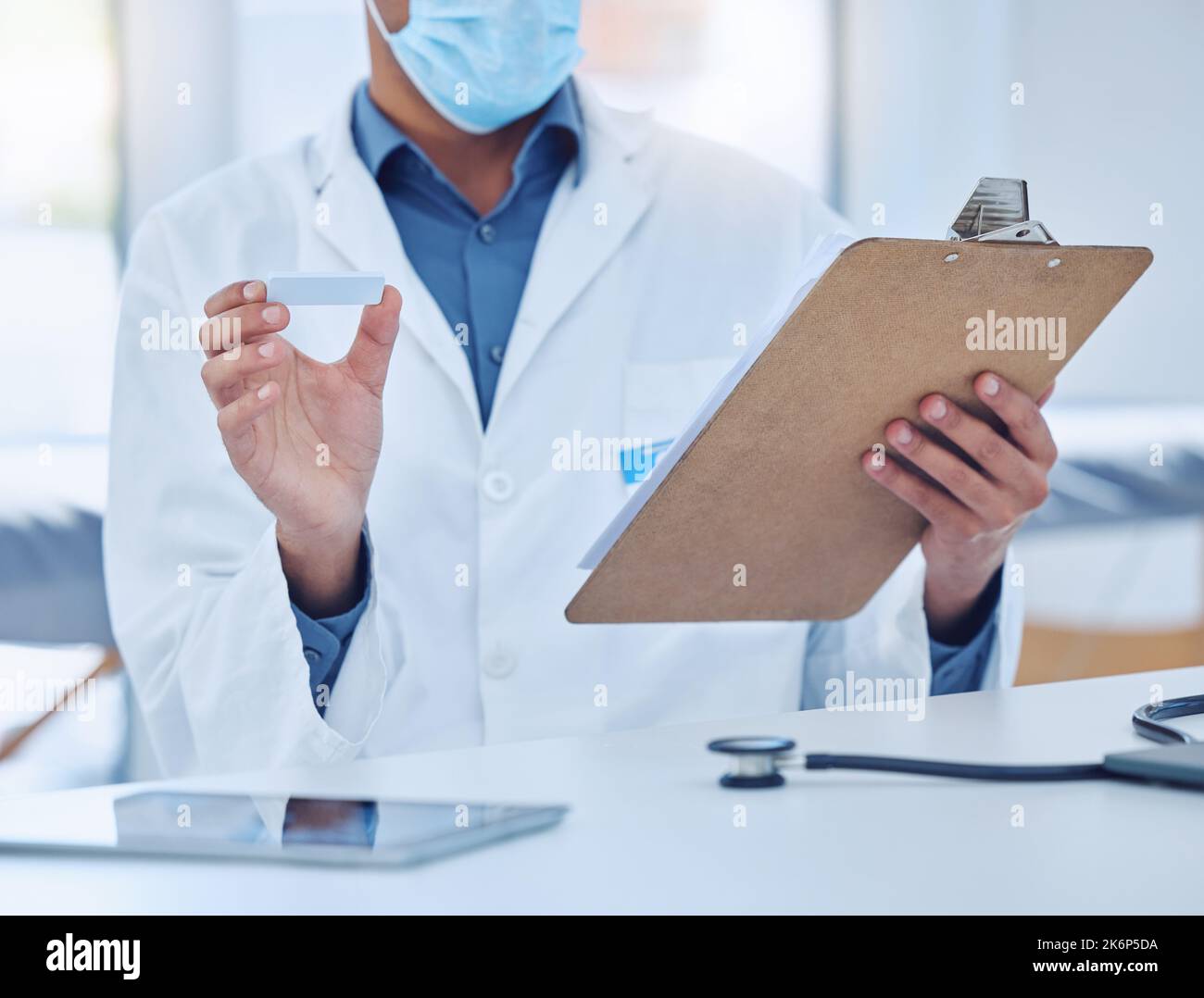 Doctor hands check covid rapid antigen clipboard test results in ...