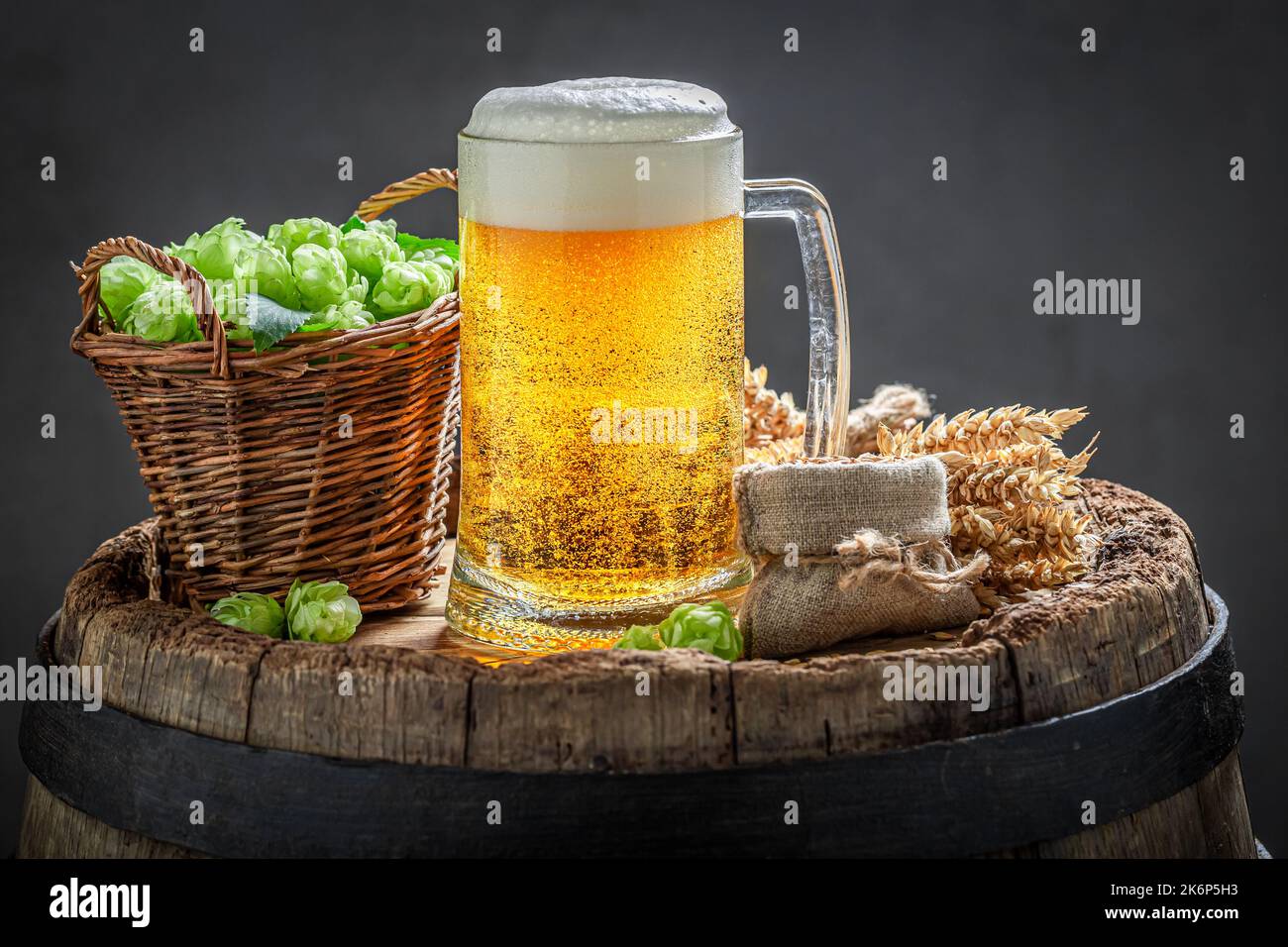 Fresh and cold light beer on wooden barrel. A golden light beer in a ...
