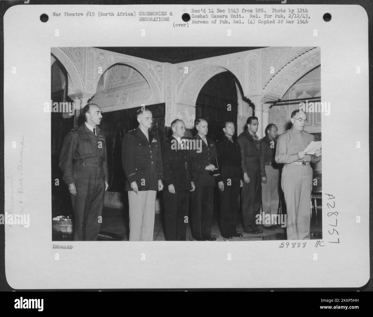 Standing at attention, a leader of the Royal Air Force and American air ...