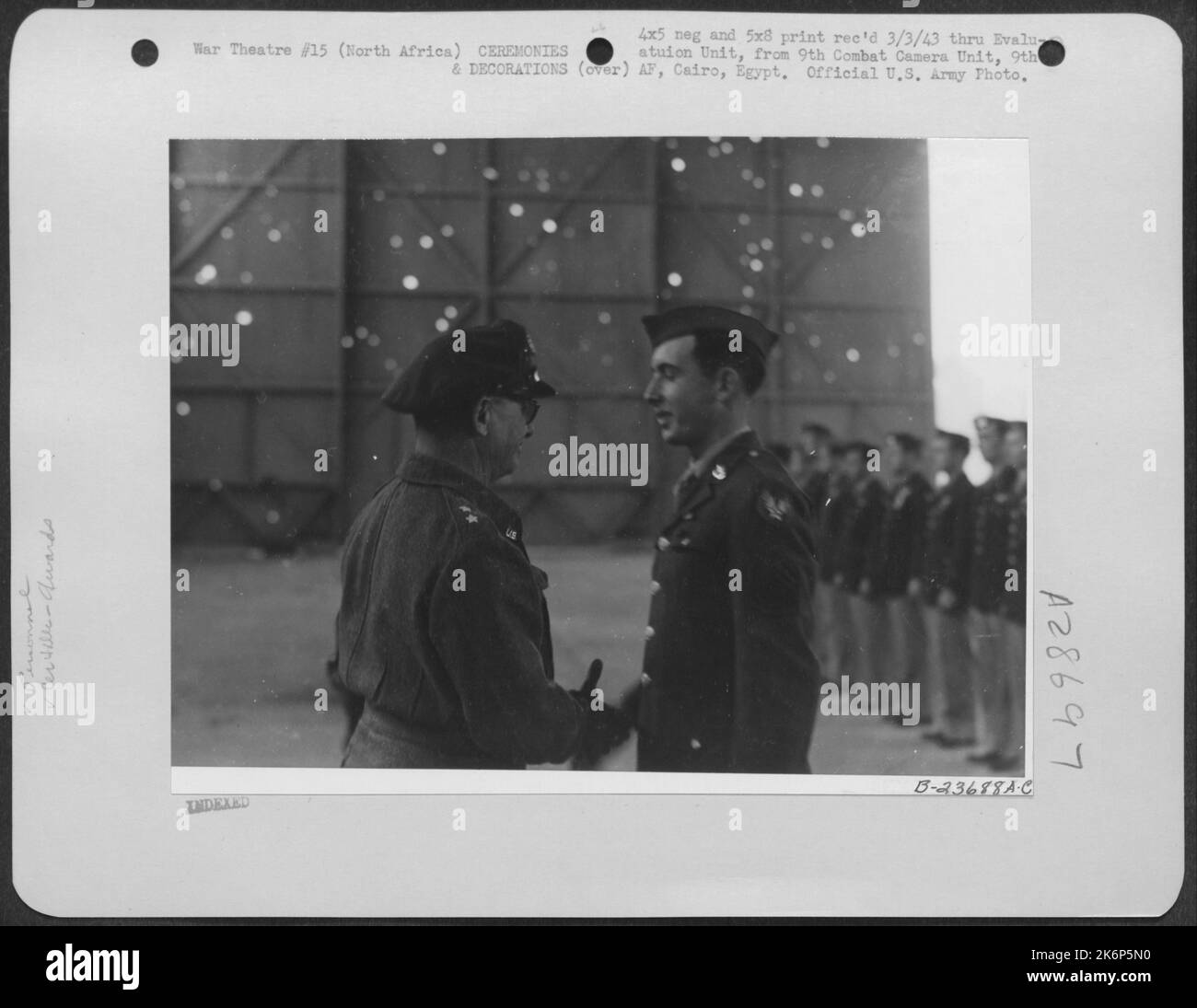 Major General Lewis H. Brereton presenting T/Sgt. Noel W. Meek ...