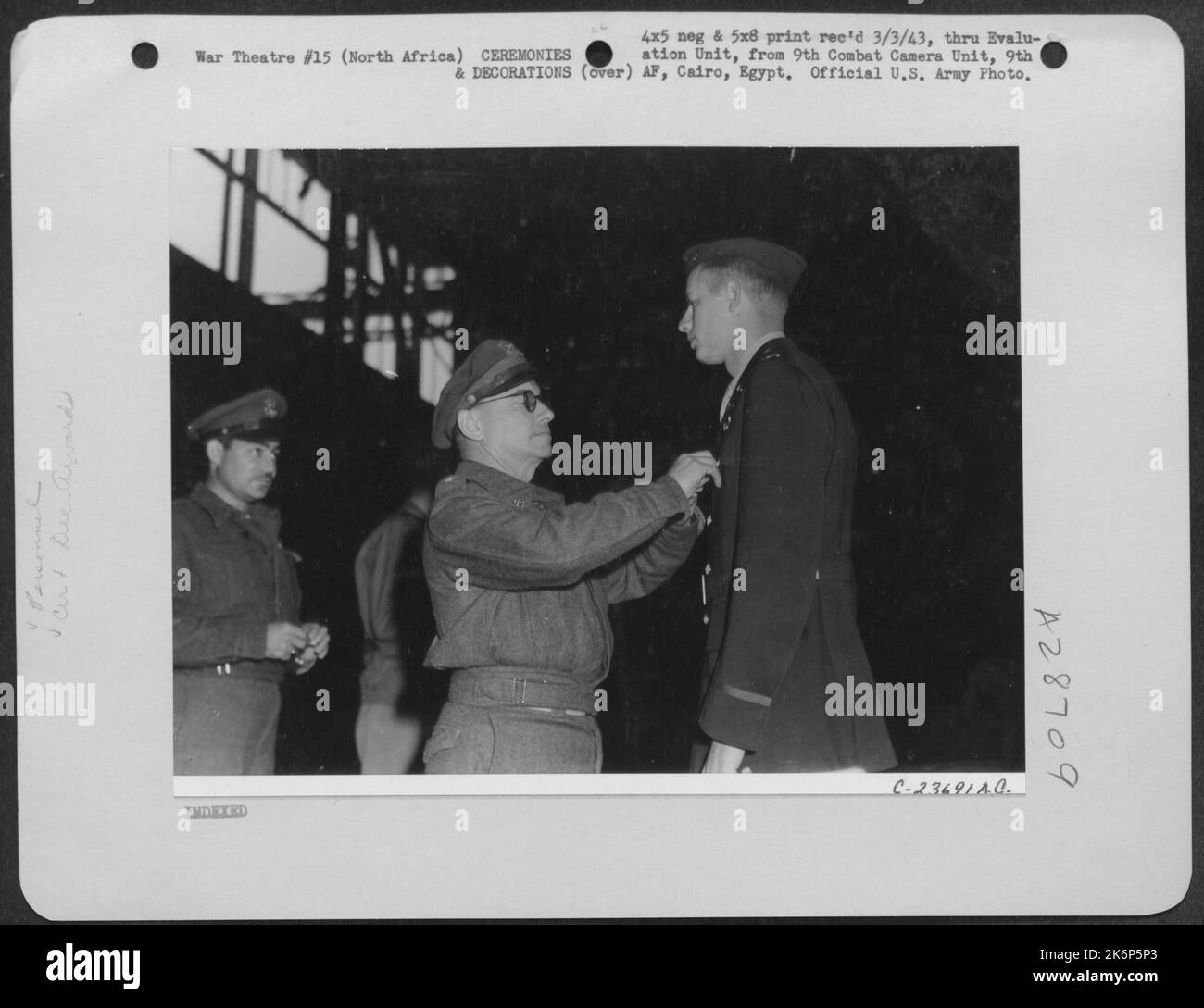 Major General Lewis H. Brereton decorating 1st Lt. Herbert O. Mengel, 0 ...
