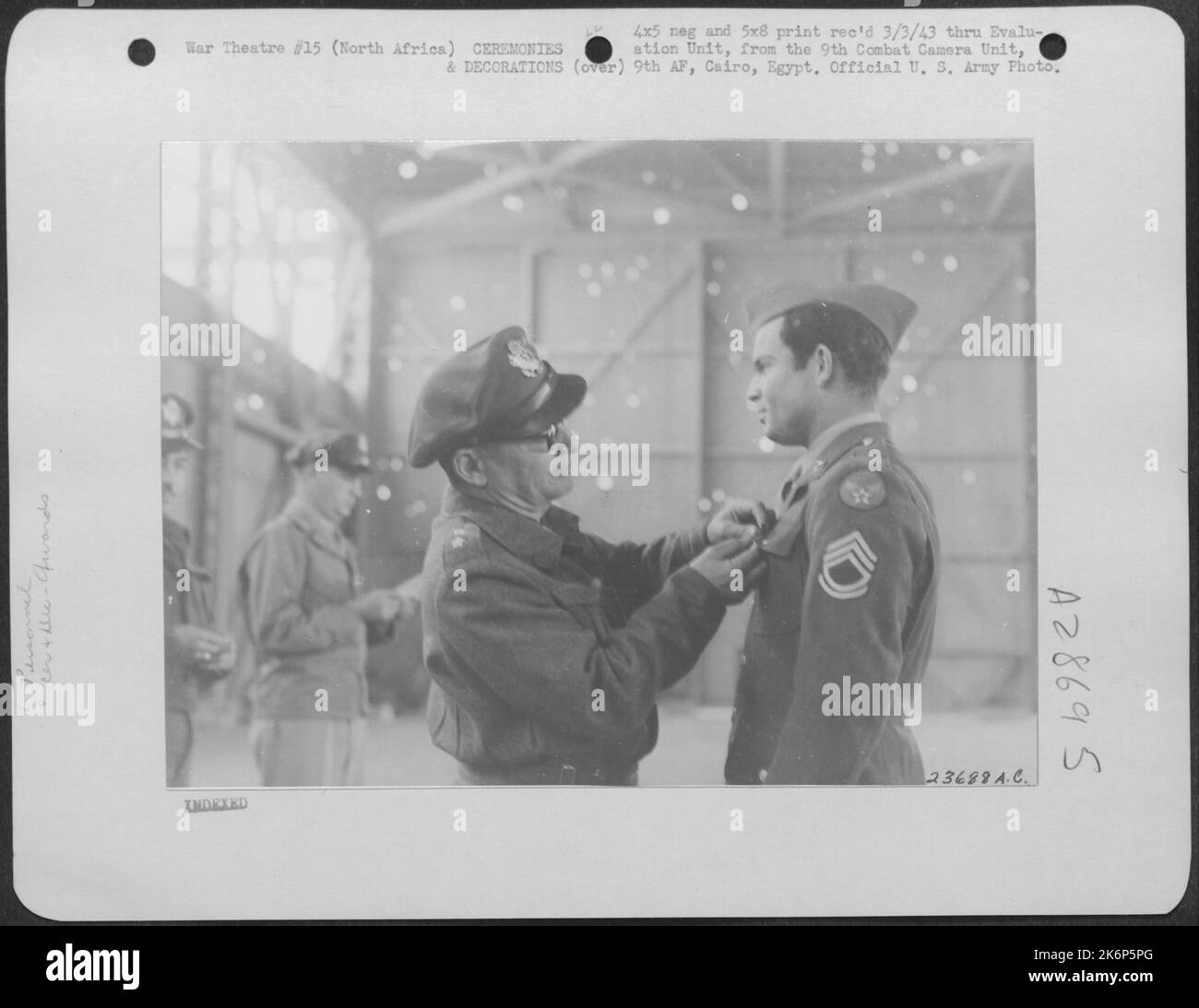 Major General Lewis H. Brereton presenting T/Sgt. Barney W. Burgin ...