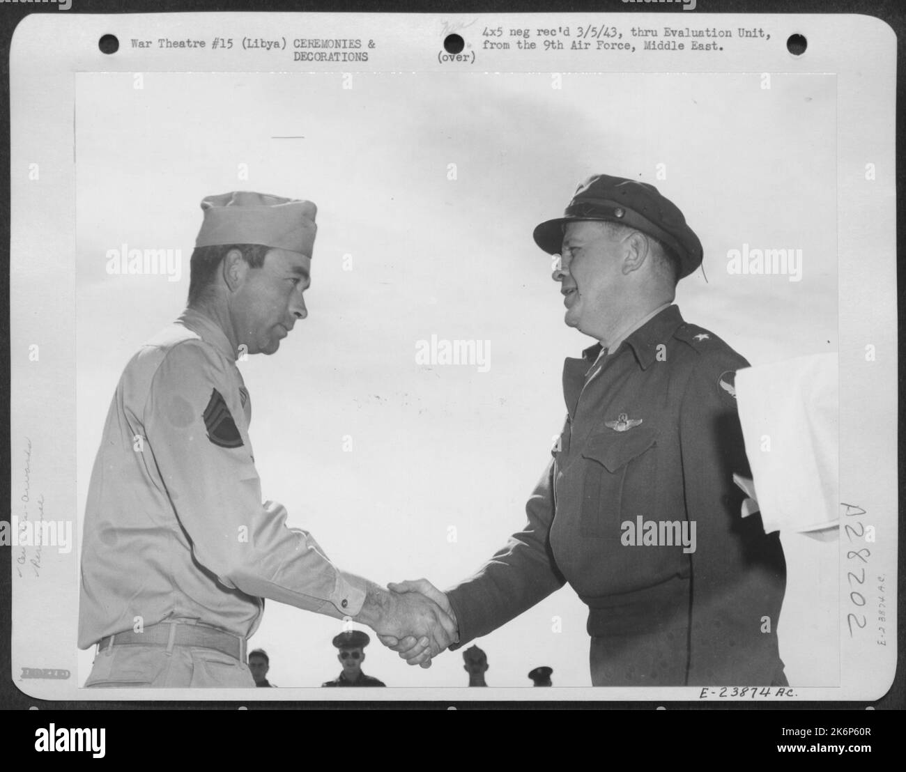 T/Sgt. Joseph G. Rose, Edina, Mo., being congratulated by Brig. General ...