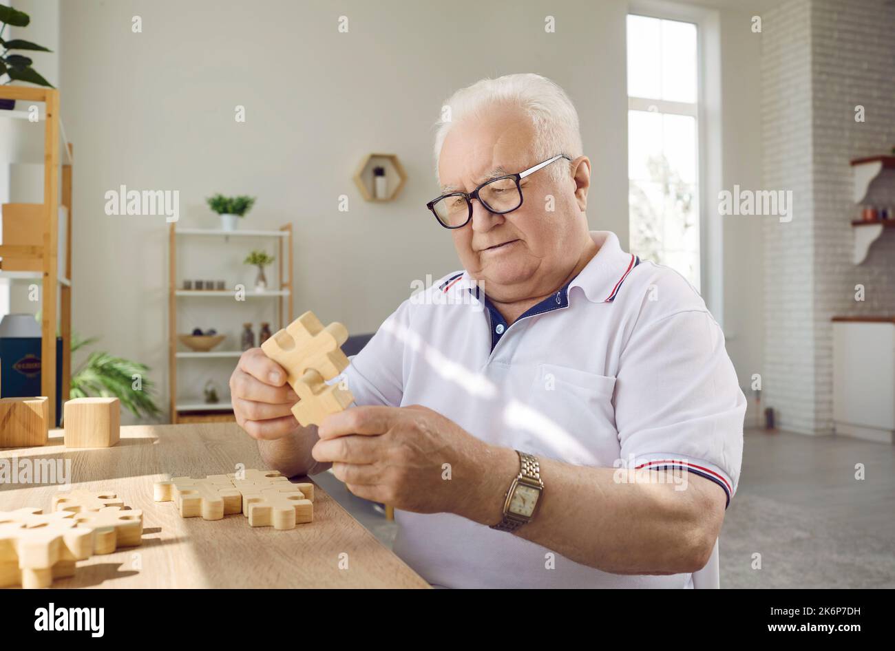 Senior man trains fine motor skills for dementia or Alzheimer's disease ...