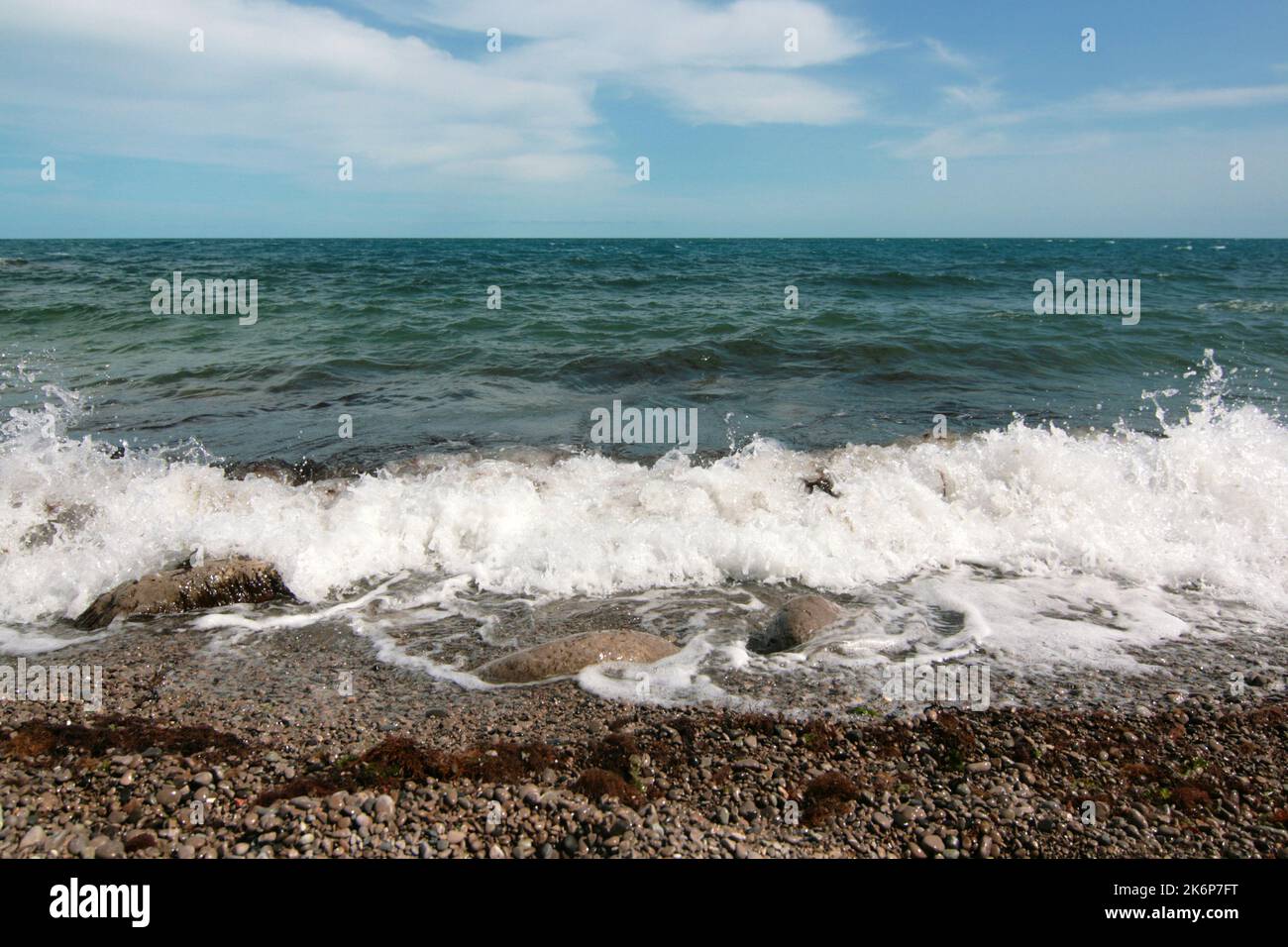 A rocky seashore with large stones in the water Stock Photo - Alamy