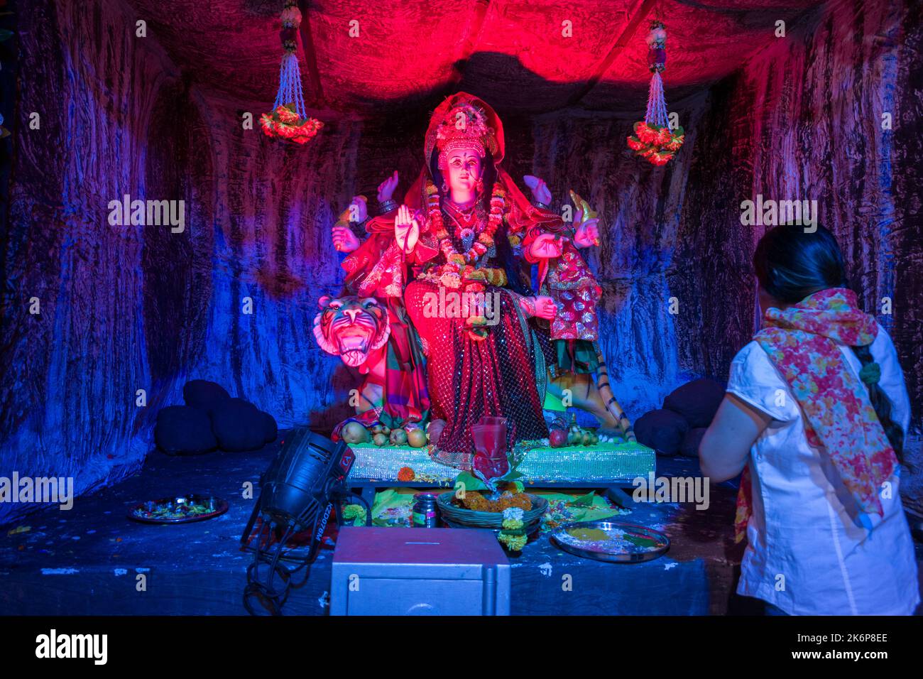 A woman praying before an idol of Maa Durga at a mandal in Mumbai for ...