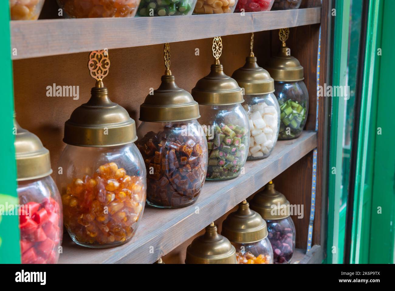 Jars of candies on the shelves of a candy store or shop. Traditional ...