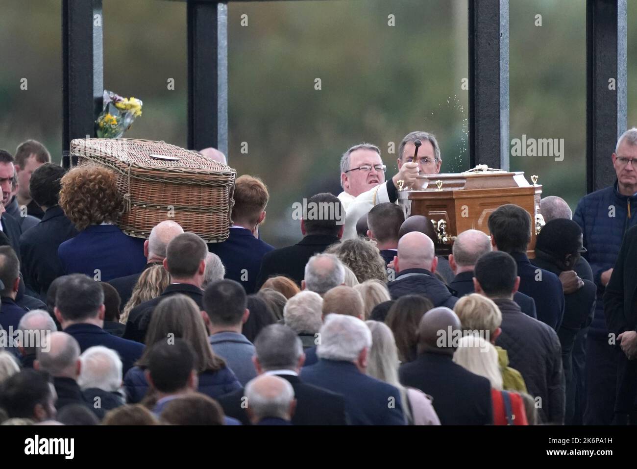 Father John Joe Duffy blesses the coffins of Robert Garwe and his five ...