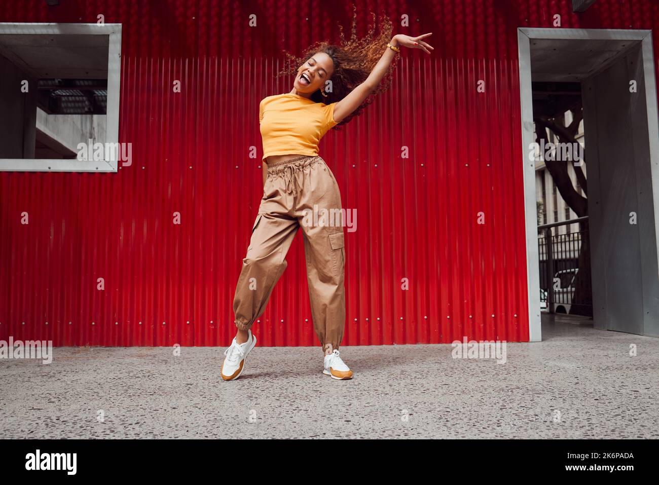 Dance, freedom and fun with a black woman on a red background, dancing ...
