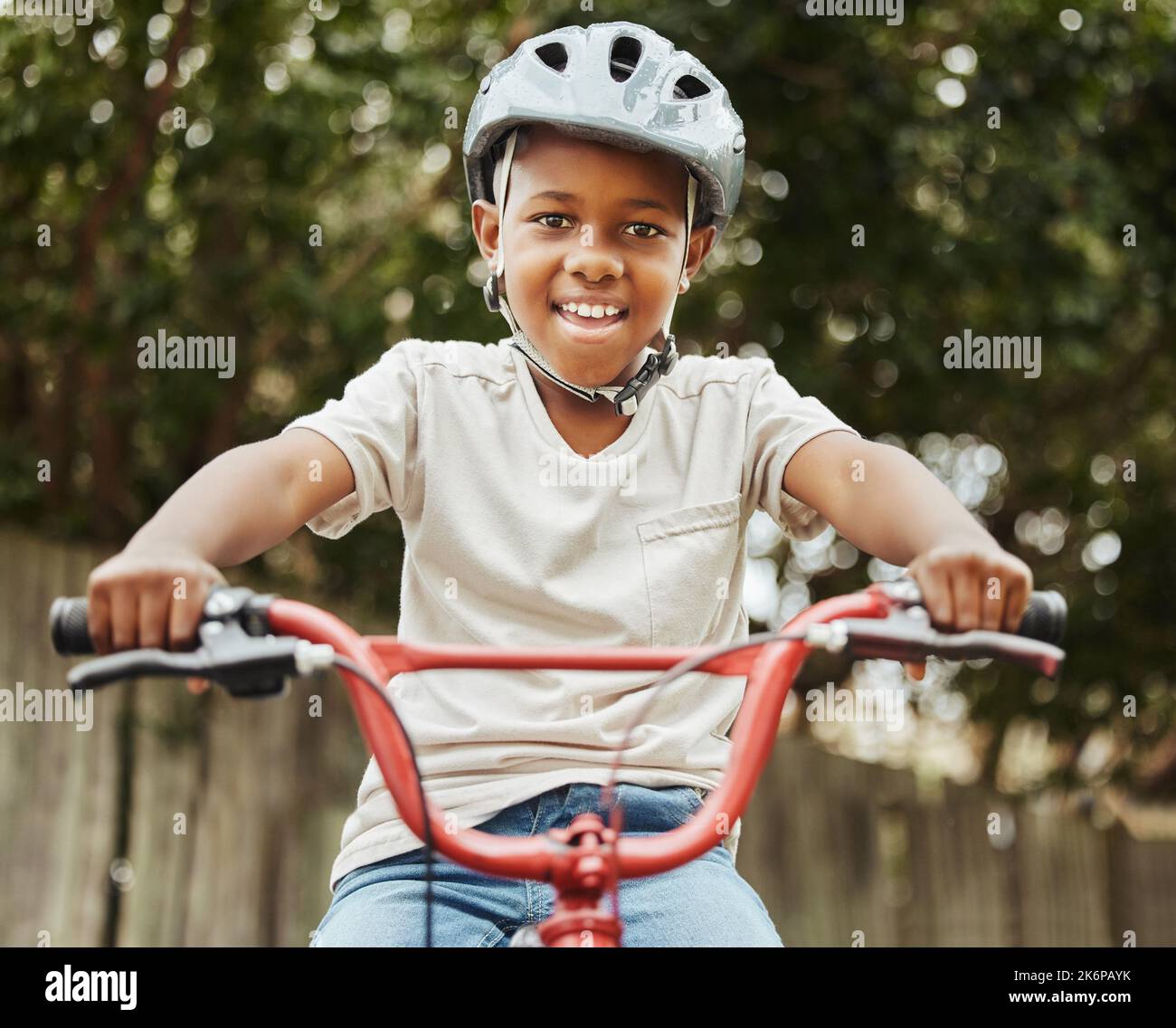 Living for weekends. a little boy riding his bicycle outside Stock ...