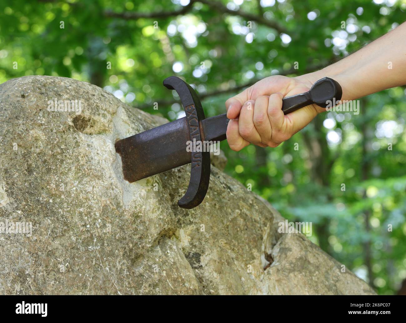 hand of the knight who tries to extract the Excalibur Sword stuck in ...