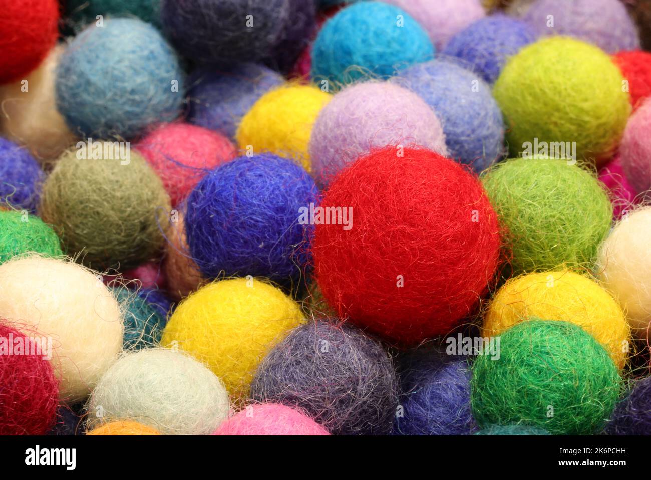 Background of many balls of carved felt wool Stock Photo - Alamy