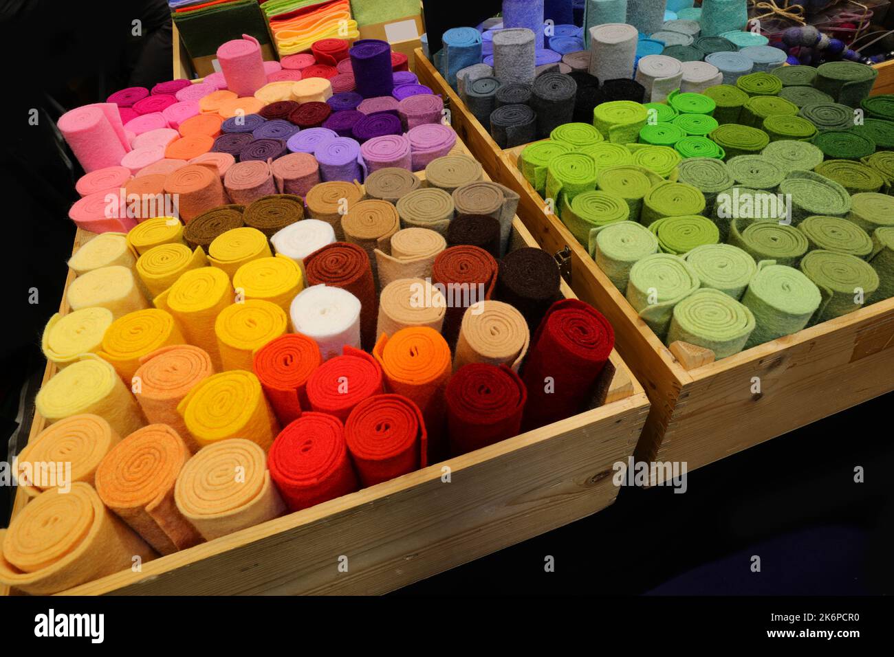 tubes of fabrics and colorful cloths and for sale in the cloth shop ...