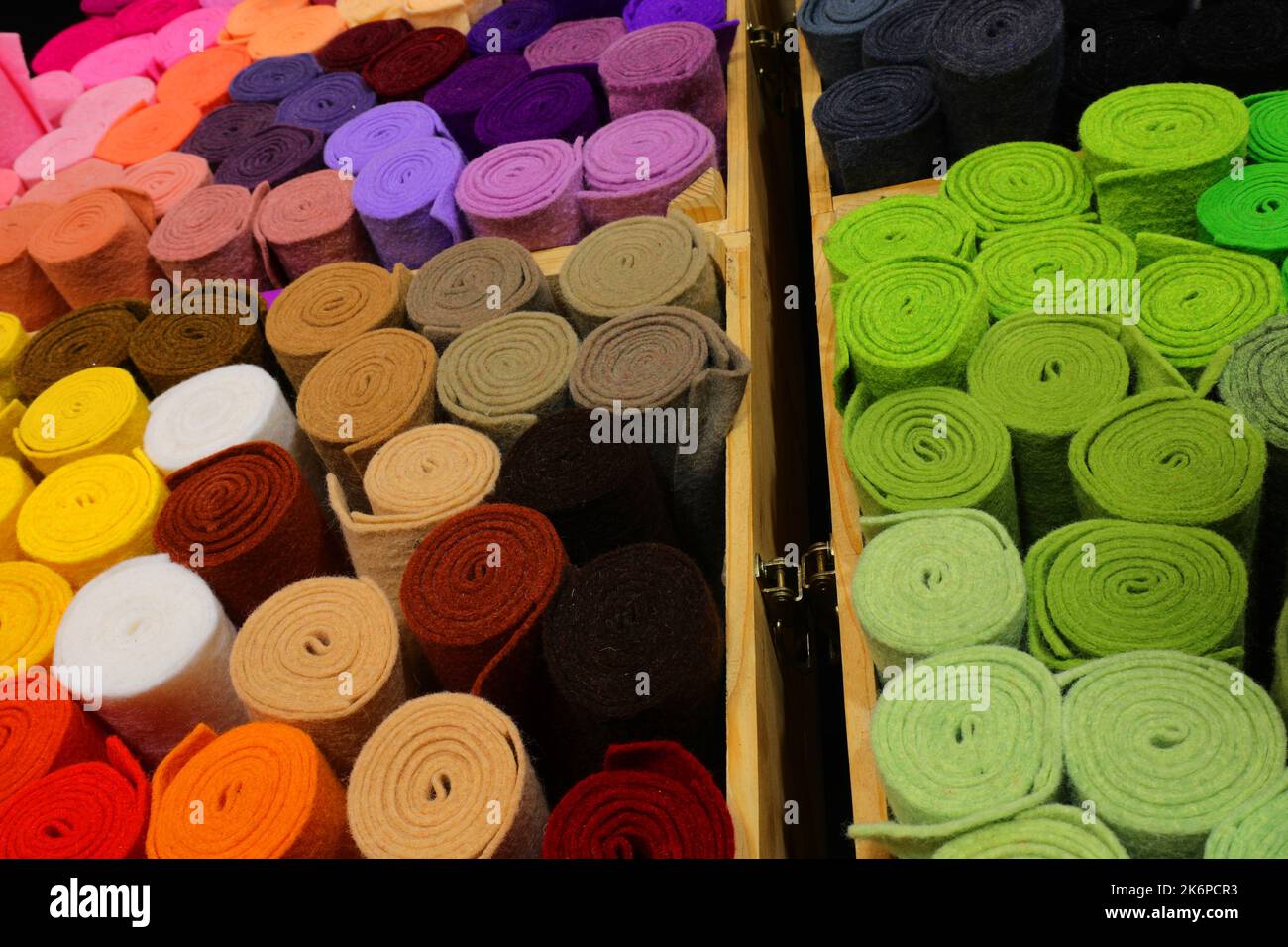 tubes of fabrics and colorful cloths and for sale in the cloth shop ...