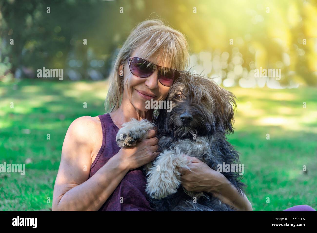 Portrait of a middle-aged blonde woman with glasses and her Catalan ...