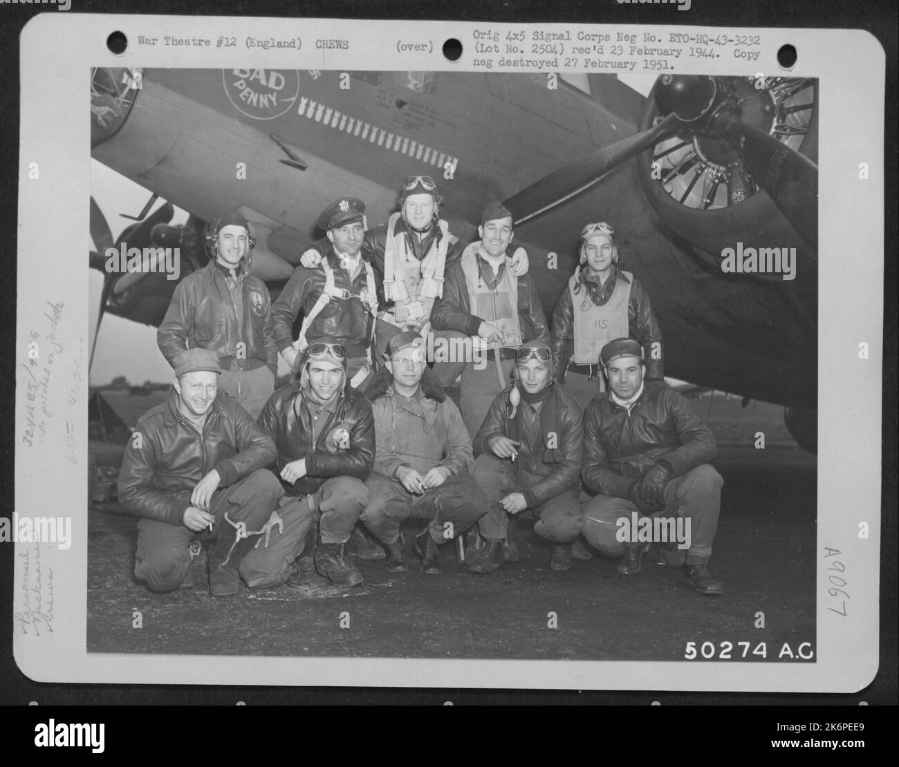 The crew of the Boeing B-17 "THE BAD PENNY" poses by their plane at an ...