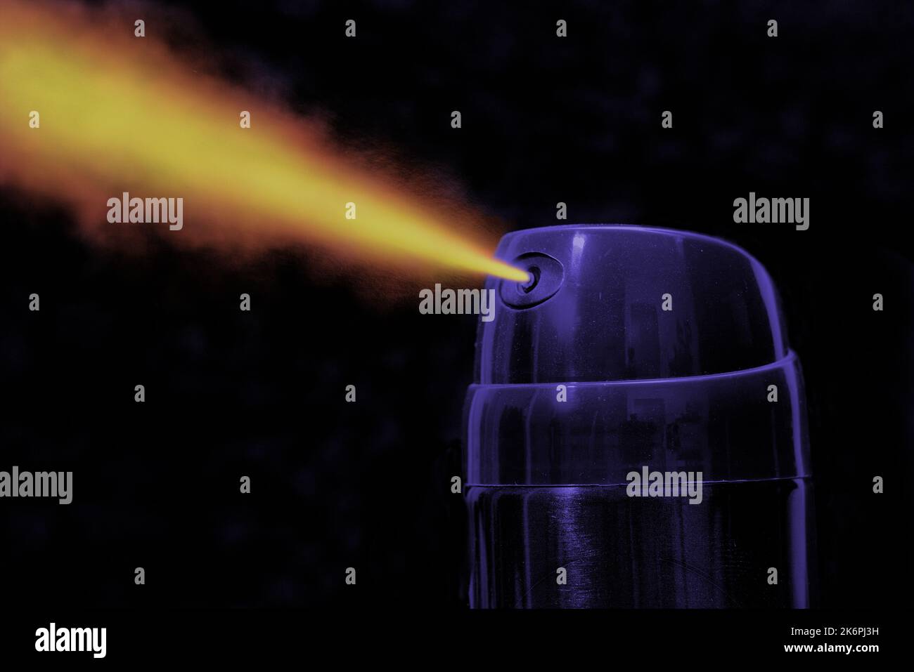 Aerosol deodorant can firing hot colored spray Stock Photo - Alamy