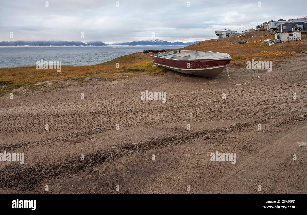 A lone fishing boat on the edge of the Arctic Ocean at the village of ...