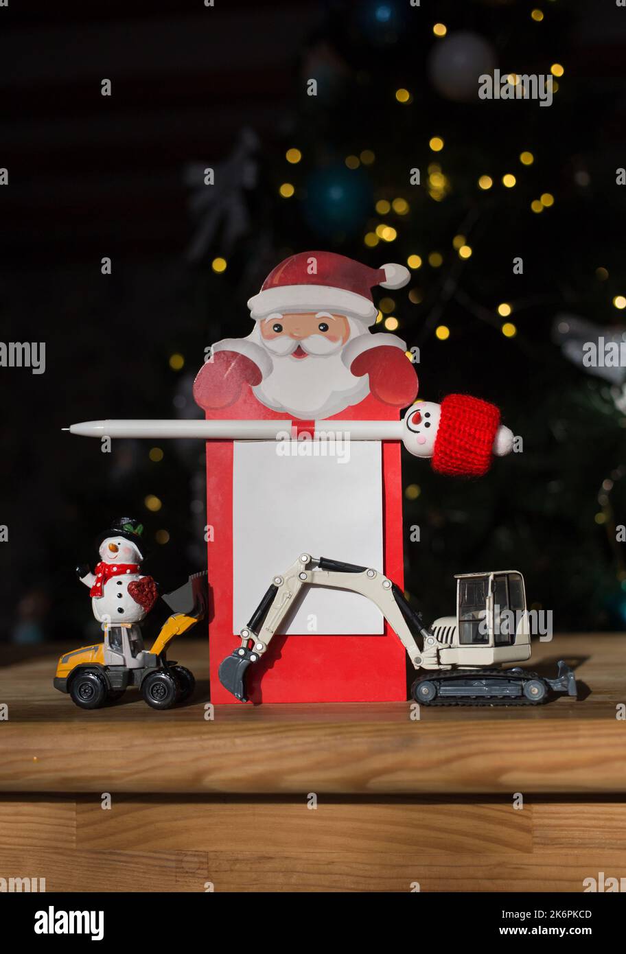 toy miniature excavators, snowman, notebook with Santa Claus, funny pen ...