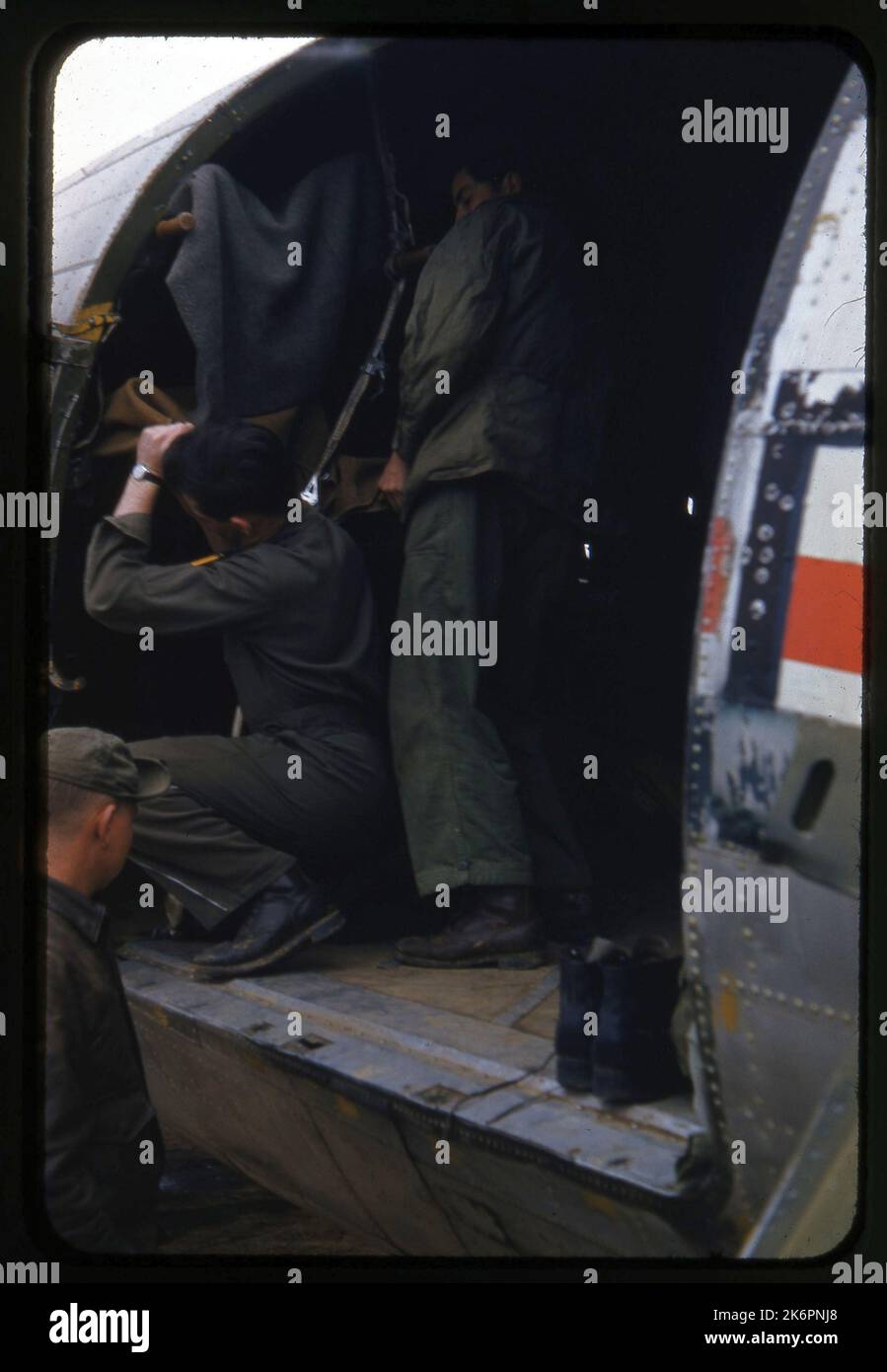 Medical personnel are shown removing wounded soldiers from a Douglas C ...