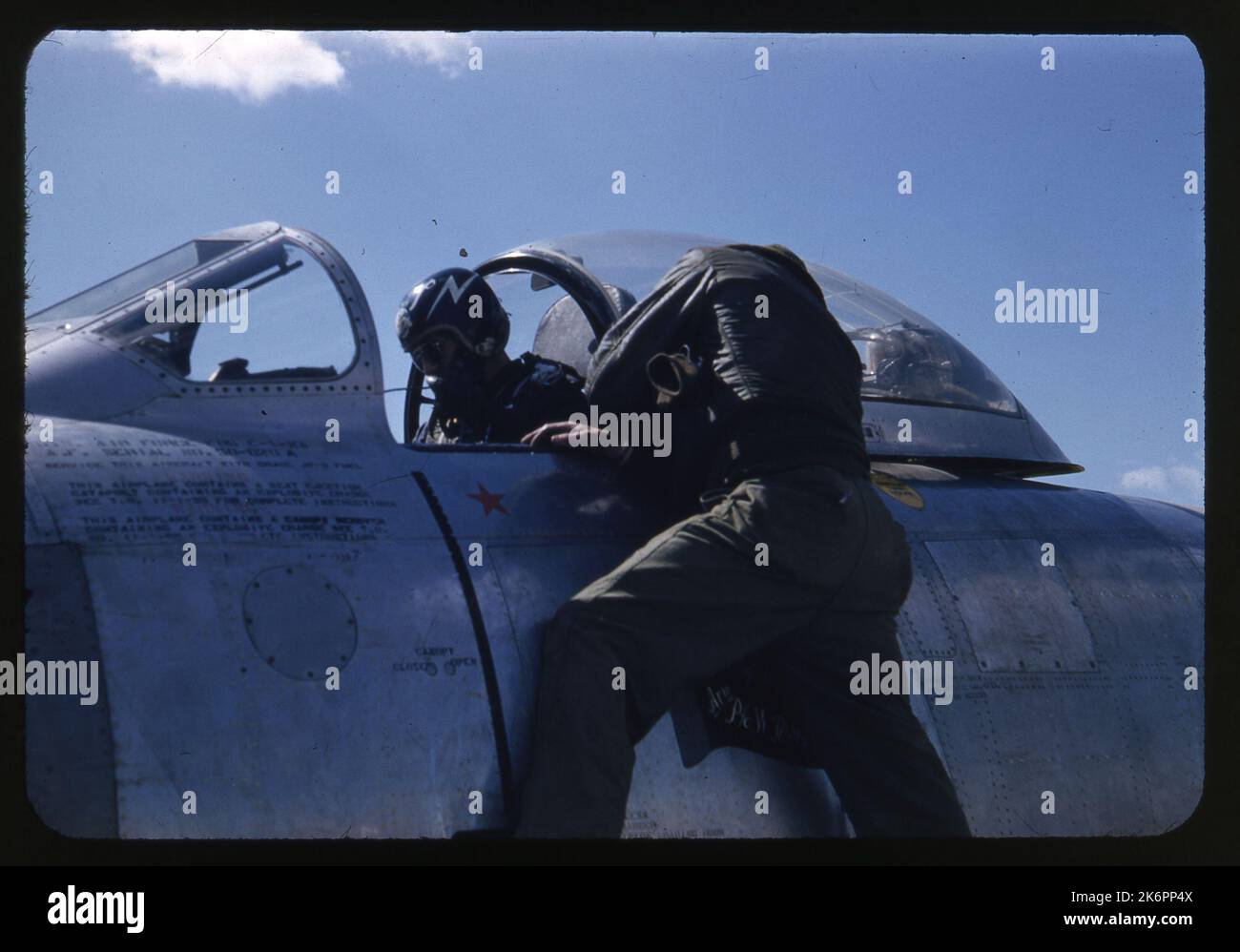 Close-up of a pilot sitting in the cockpit of a North American F-86 ...