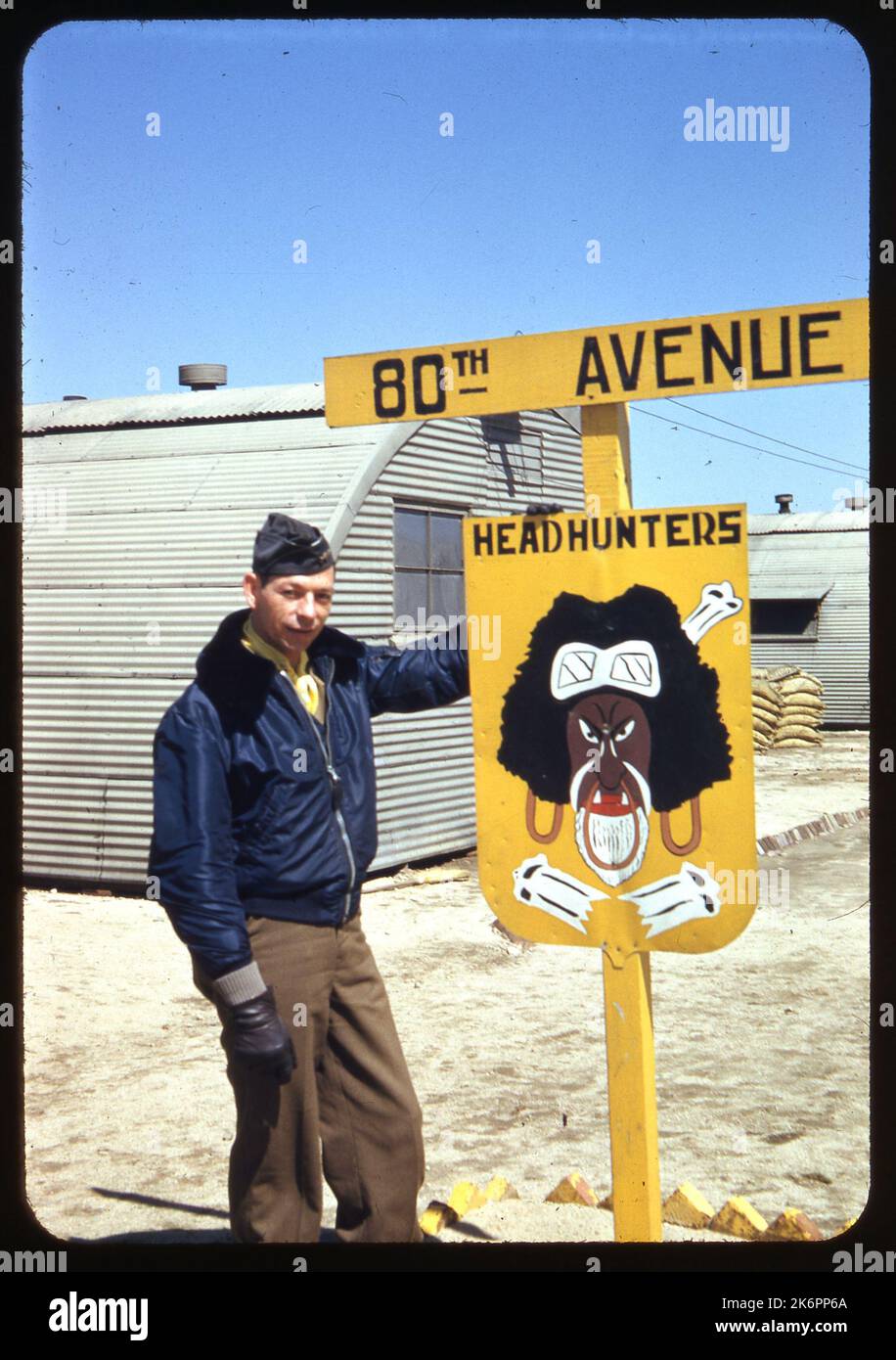 Officer standing beside 80th Fighter Bomber Squadron (FBS) "Headhunters ...